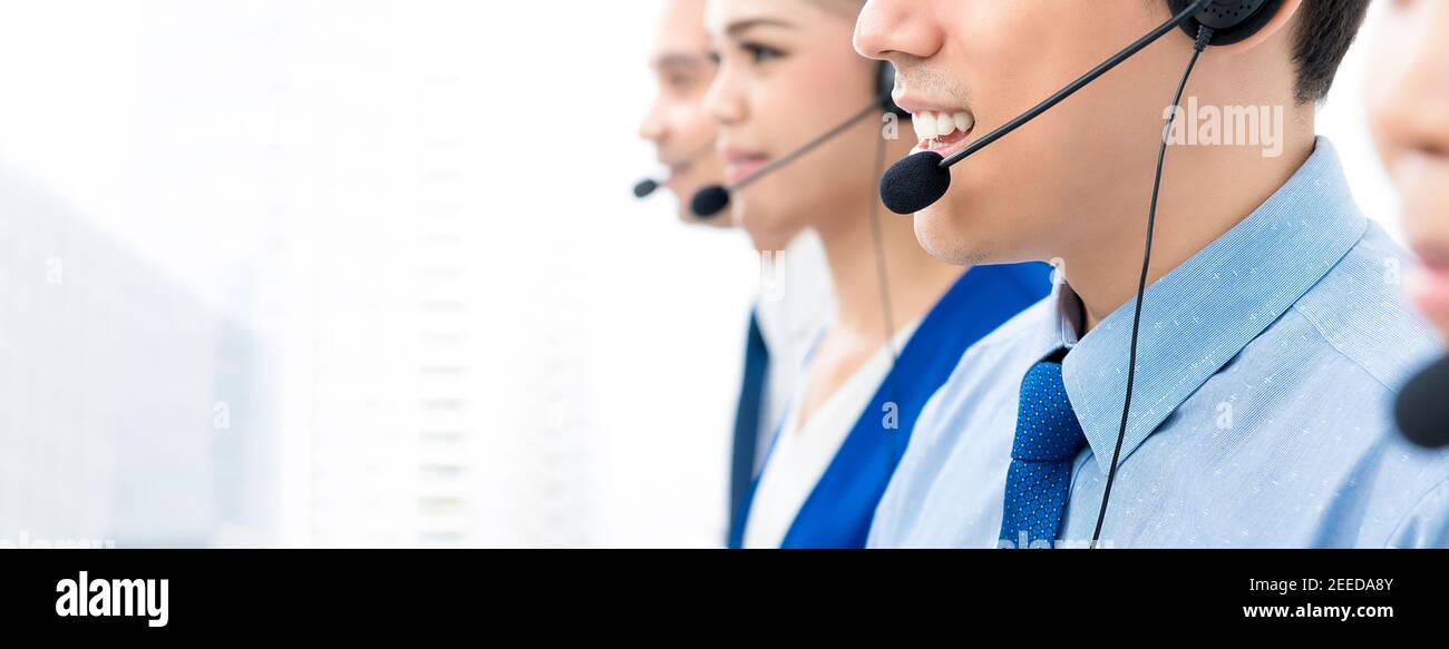 Call center agents talking on the phone to customers with a friendly ...