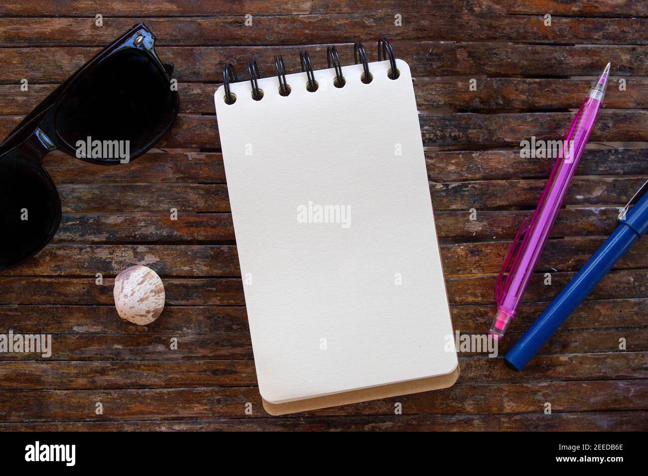 Spiral notepad blank page and pen on wooden background. Empty ...