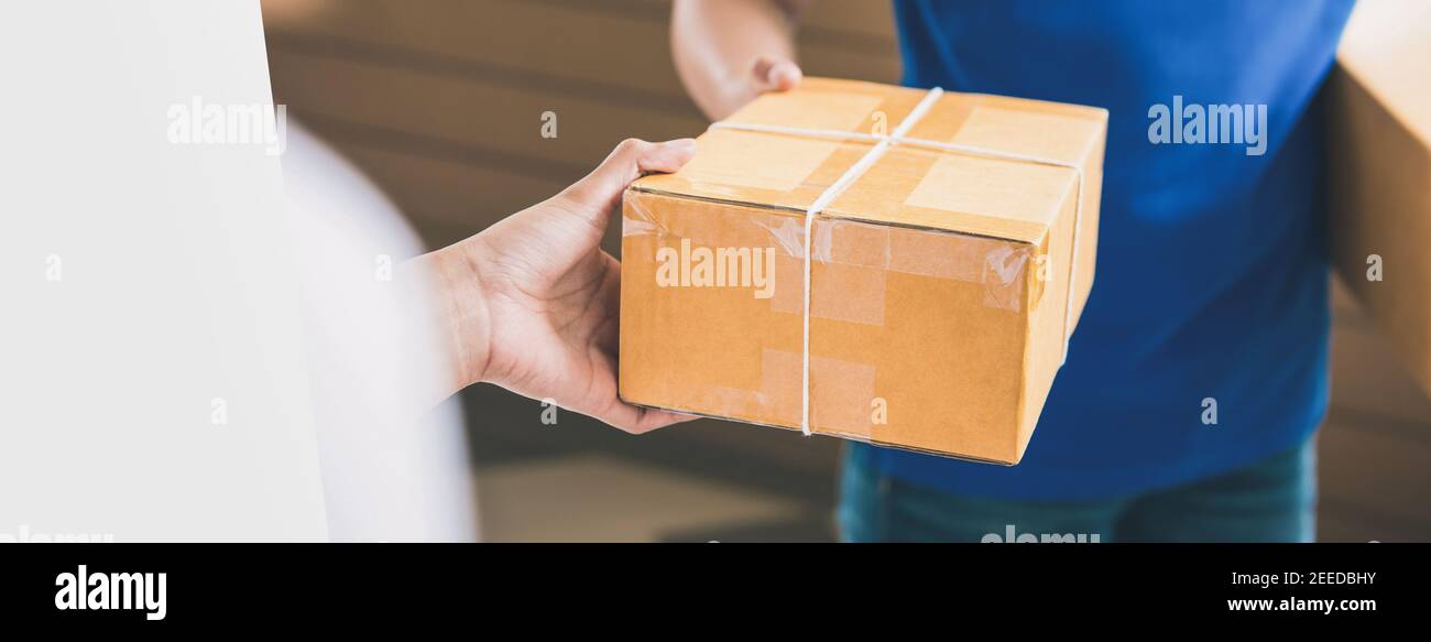 Delivery man handing a parcel over to a female customer, courier ...