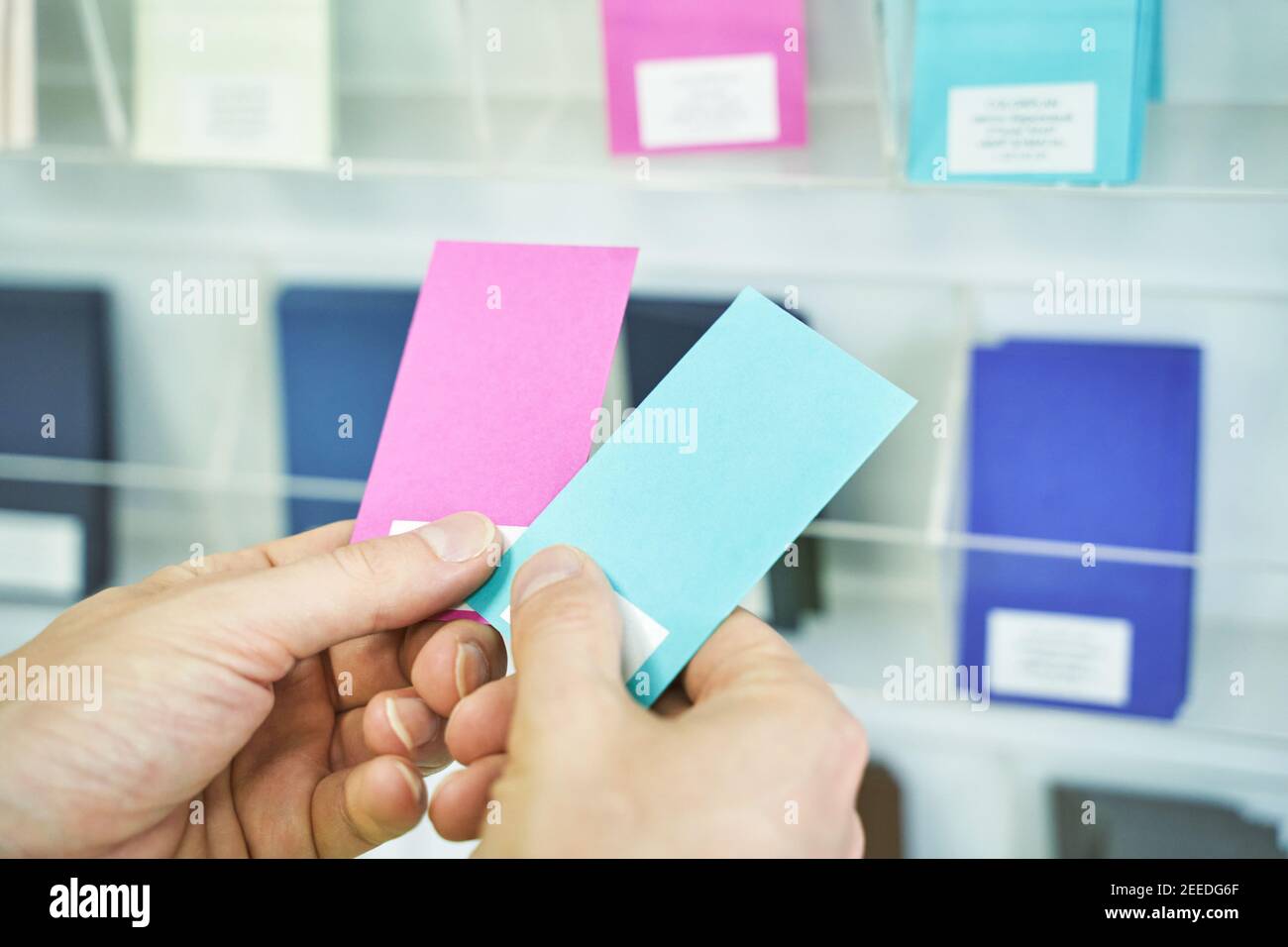 Choosing wall color sample. Man hands holding paper example. Blue or ...