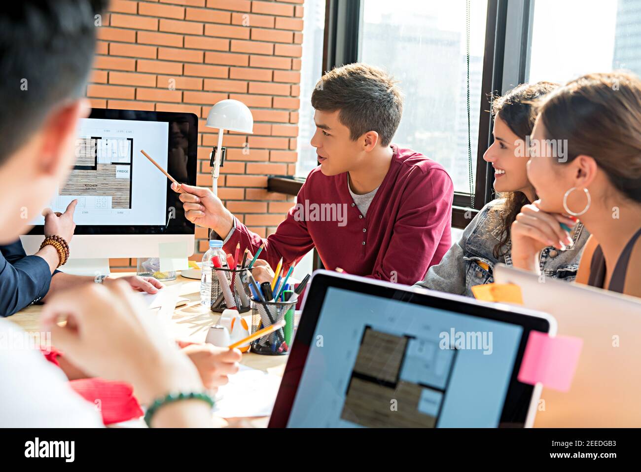 Architects or interior designer team discussing project together in the ...