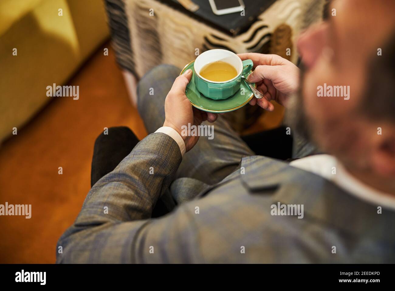 Fragment photo of man in suit drinking tea Stock Photo - Alamy