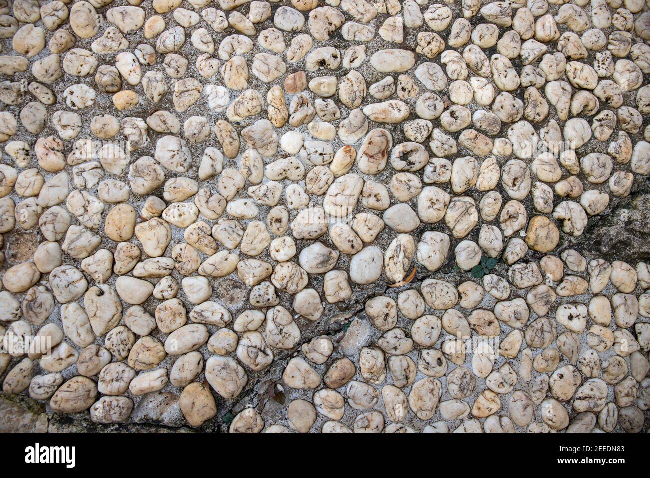 Grungy photo texture of pebble paving. Tiny marble gravel road. Pebble ...
