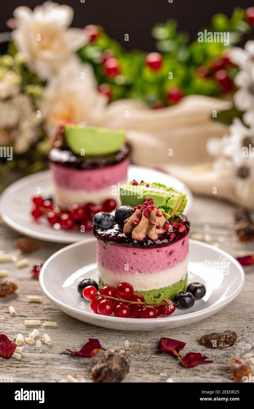 Three coloured mini round layer cake with fruit jelly Stock Photo - Alamy