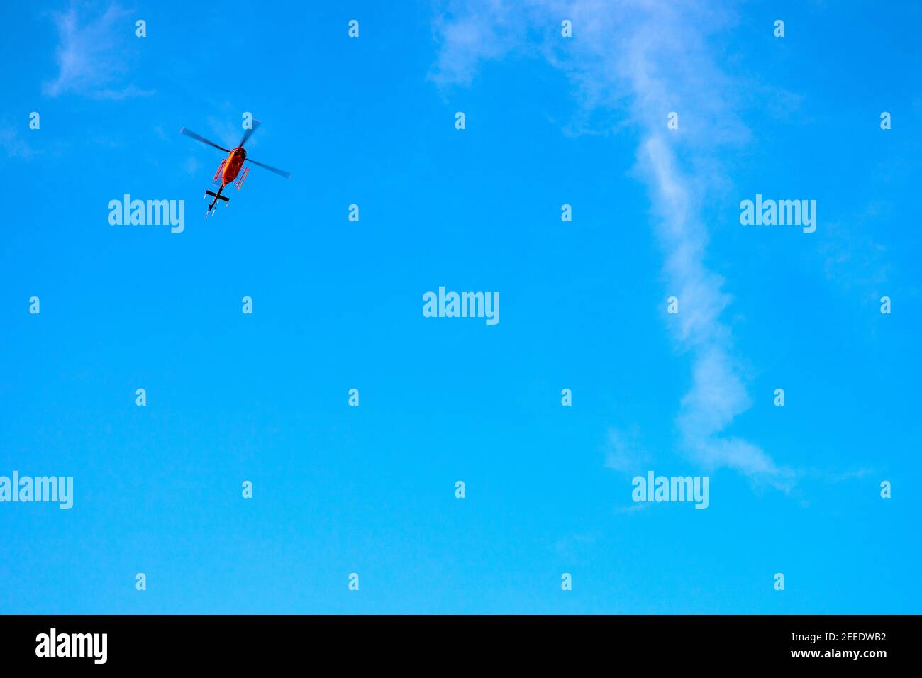 Red helicopter in blue sky. Special transportation for emergency ...