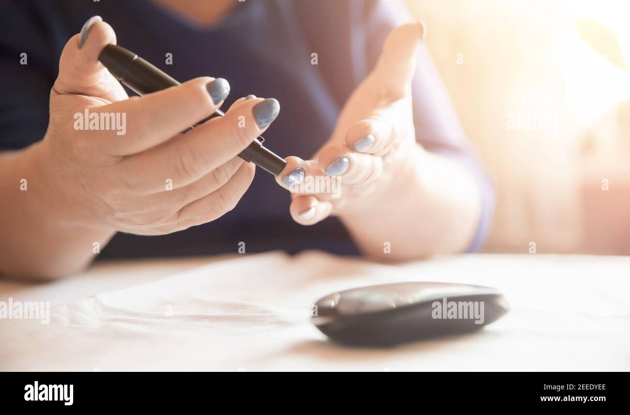 Woman use glucometer for checks blood sugar level for diabetes, insulin ...