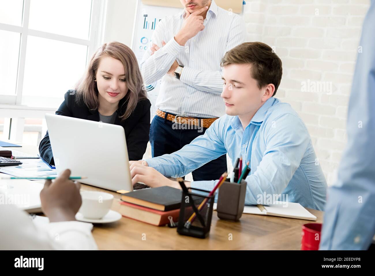 Business team working together on laptop computer in sales meeting at ...