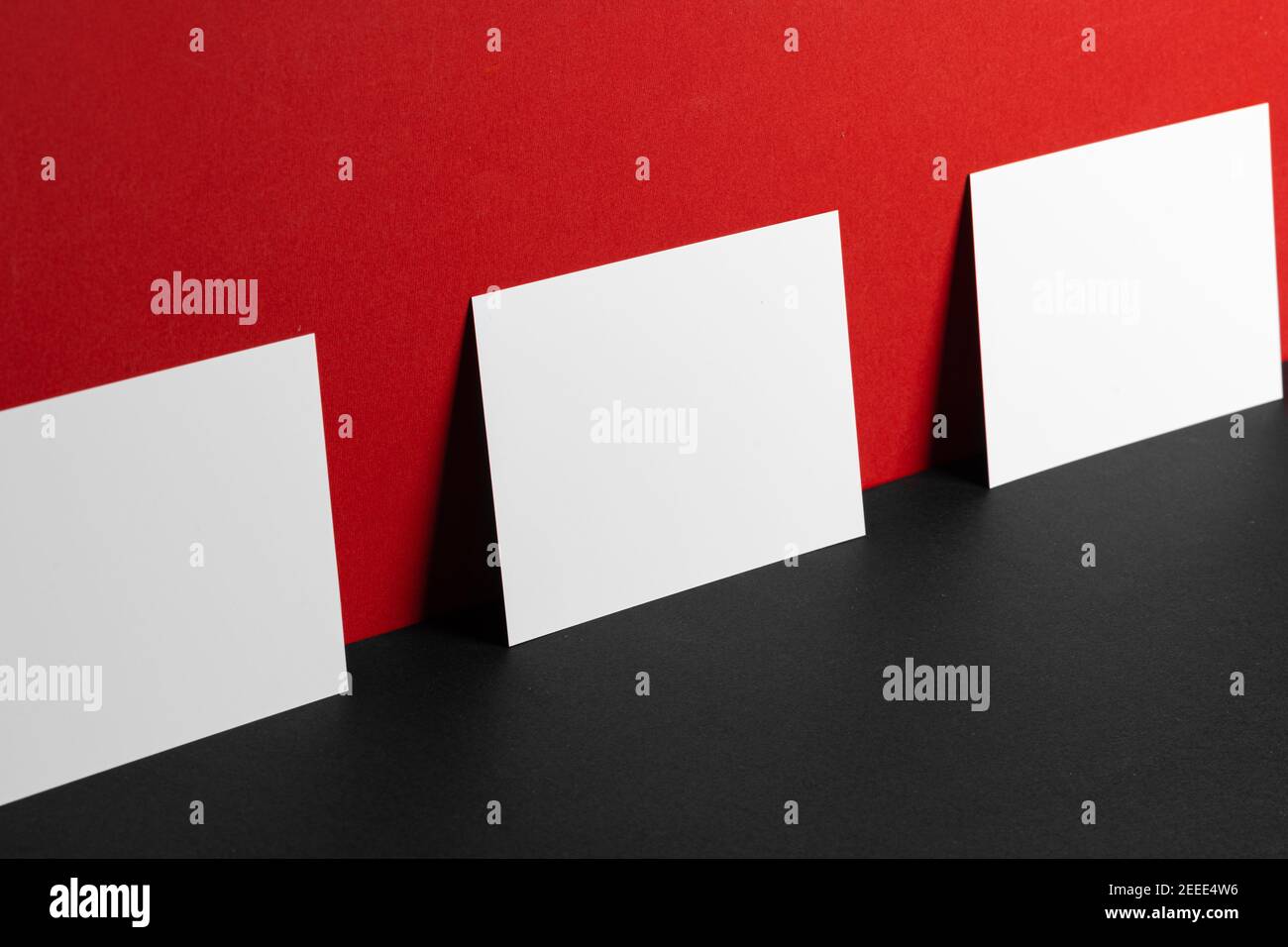 Blank white business cards on red and black paper background Stock ...