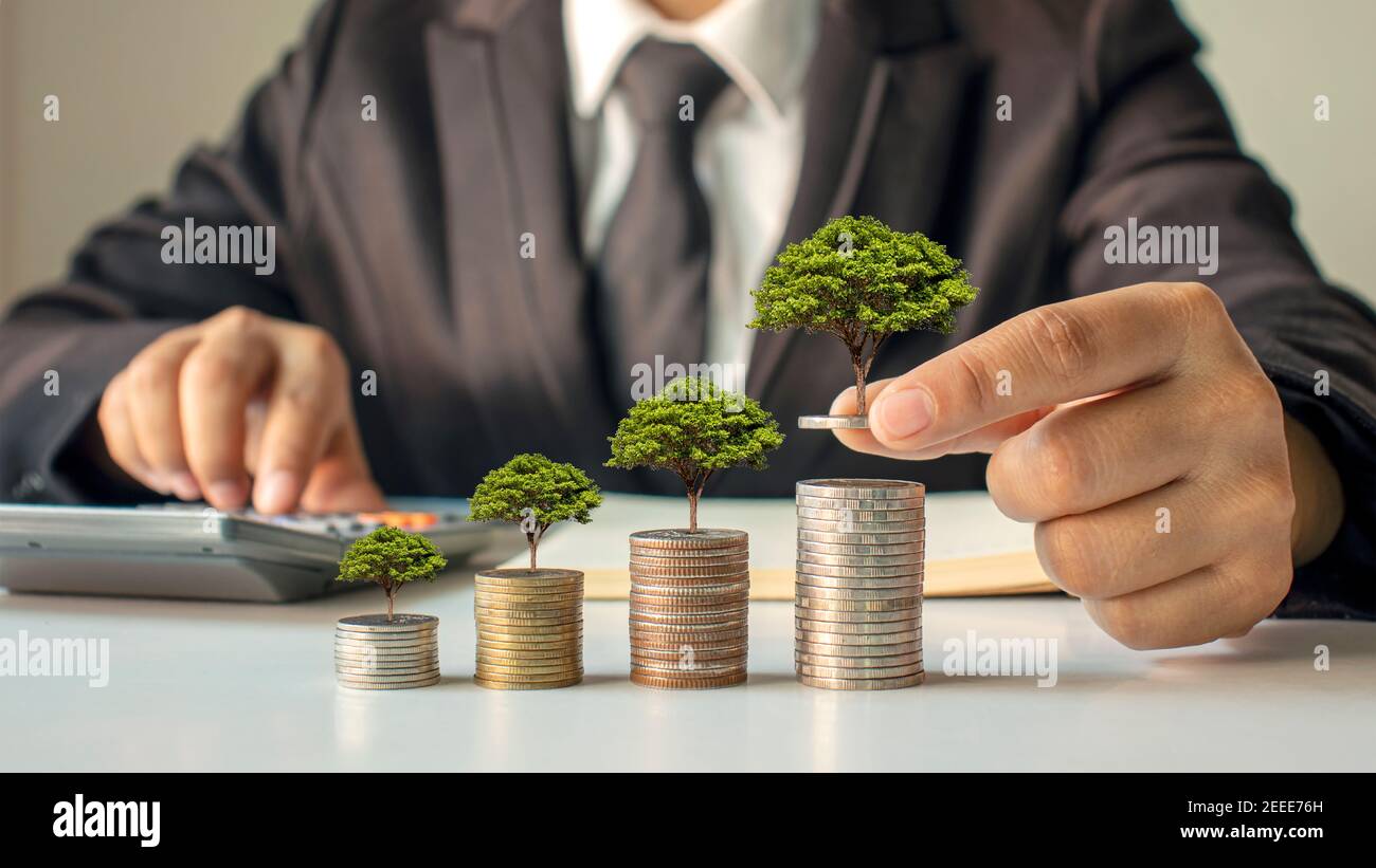 Business people planting trees on a pile of money money saving ideas ...