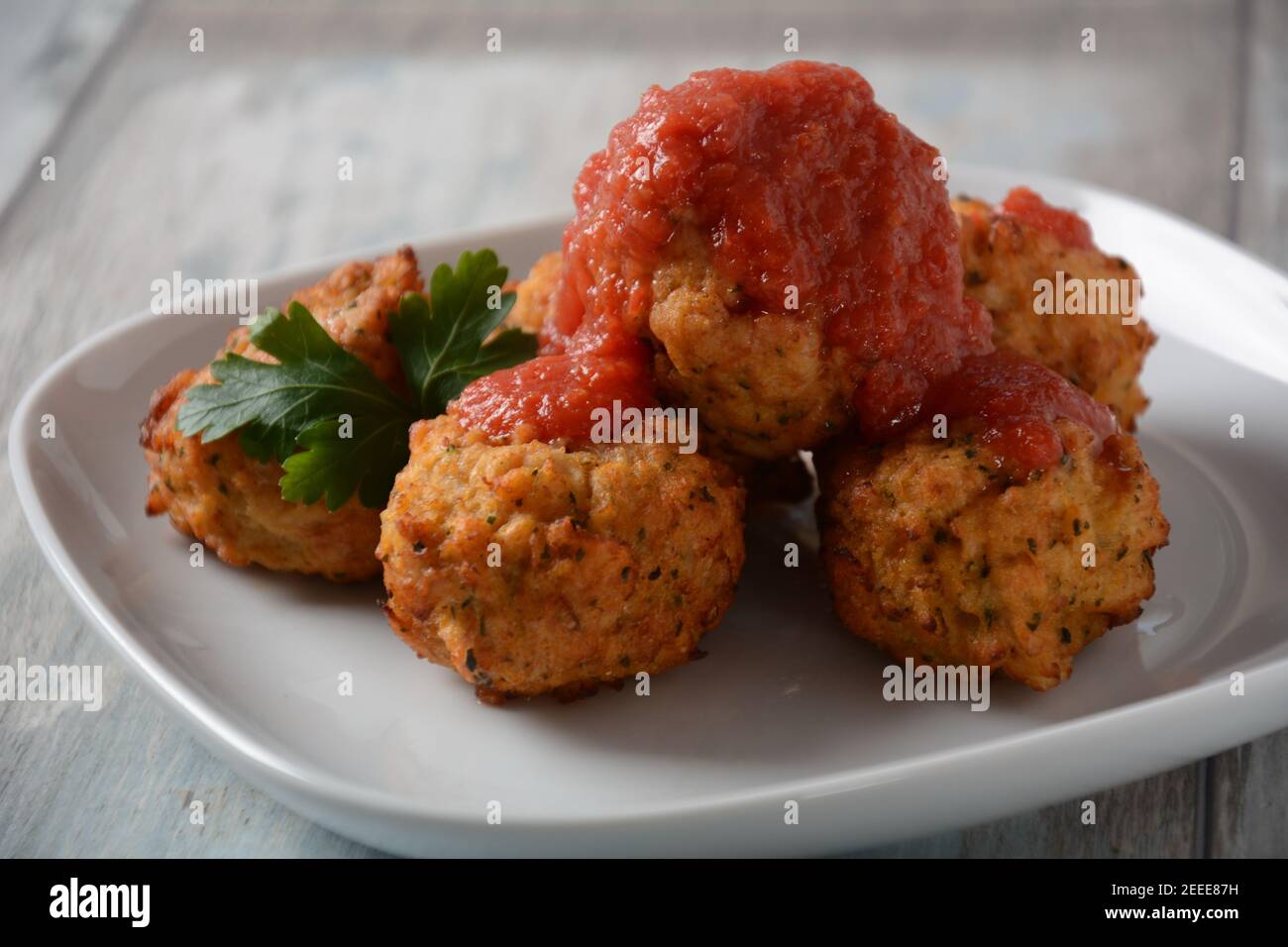 Fried fish meatballs with parsley Stock Photo - Alamy