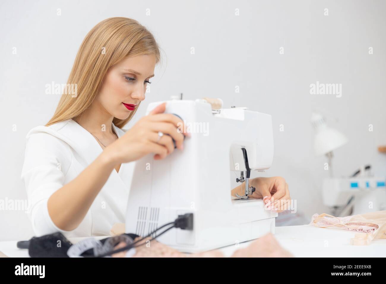 Woman works cloth on sewing hi-res stock photography and images - Alamy