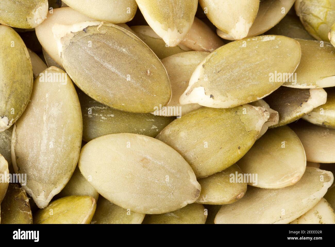 raw peeled pumpkin seeds close up background Stock Photo - Alamy