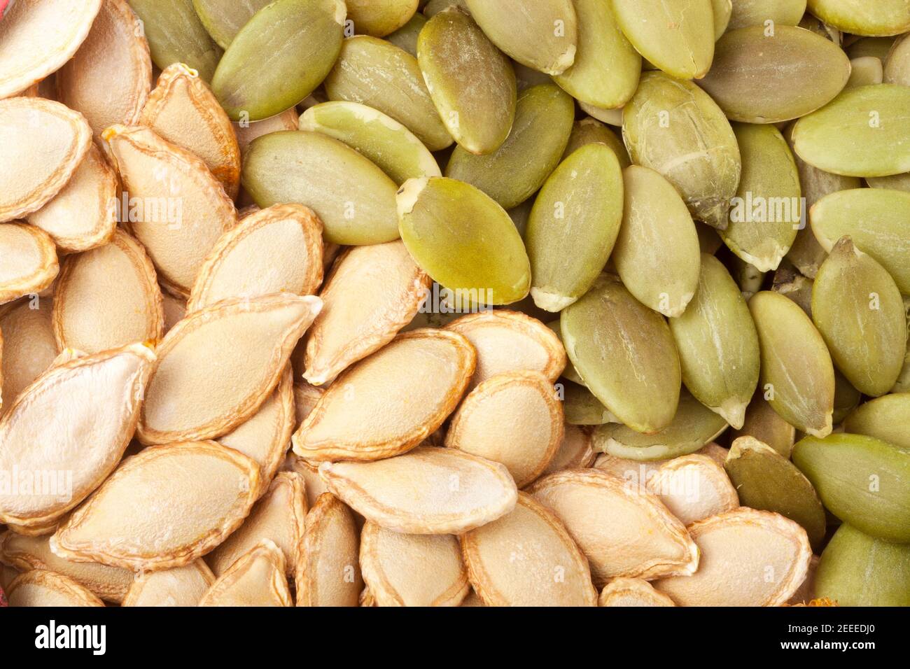 peeled pumpkin seeds or whole background macro Stock Photo - Alamy