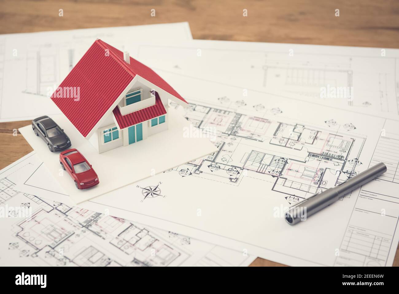 Blueprints and house model on the table - architecture and real estate ...