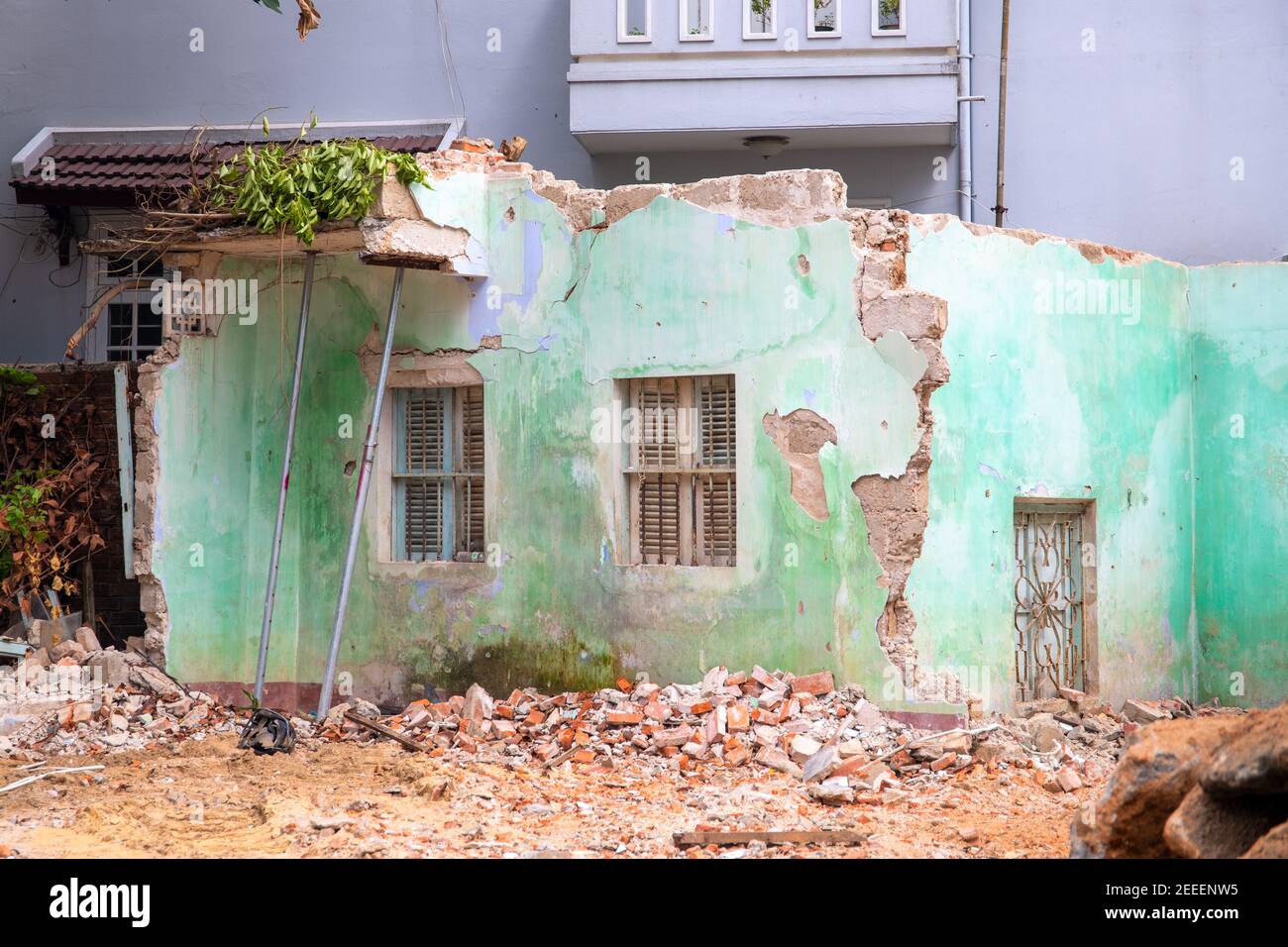 Broken house after earthquake. Old building deconstruction with new ...