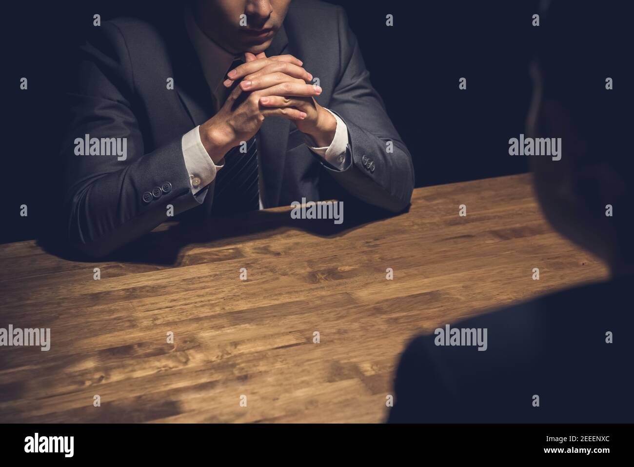 Detective Interviewing Suspect In Dark Room Investigation And