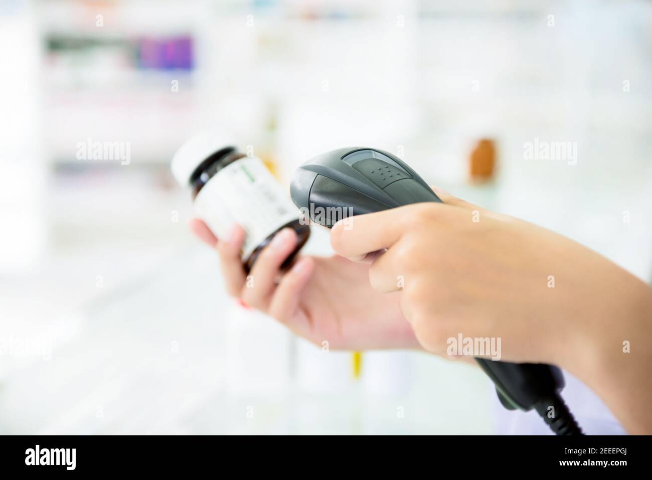 Pharmacist scanning medicine bottle with barcode scanner in pharmacy ...
