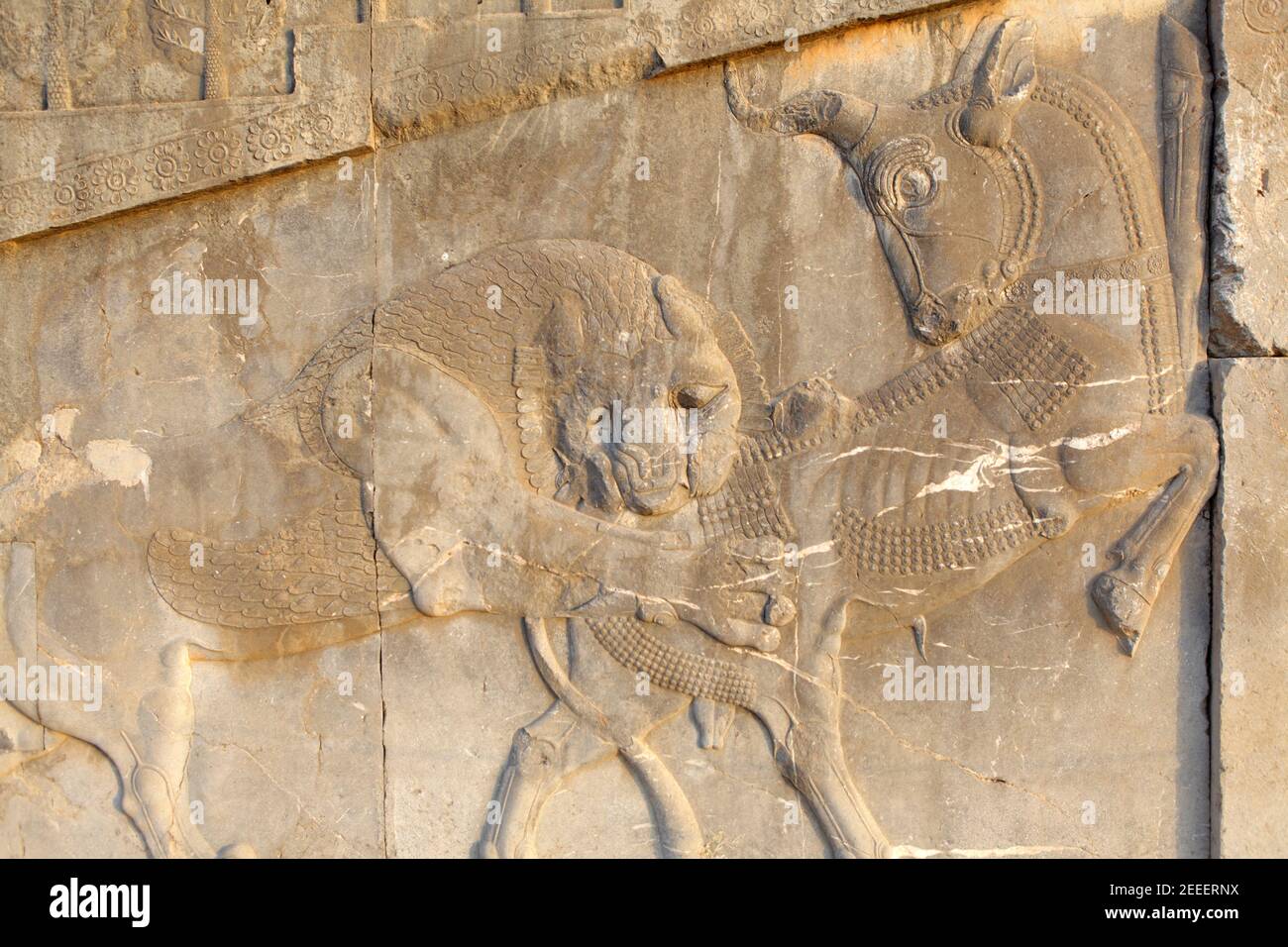 Scene from Persian mythology in the Apadana stairs, Persepolis, Iran ...