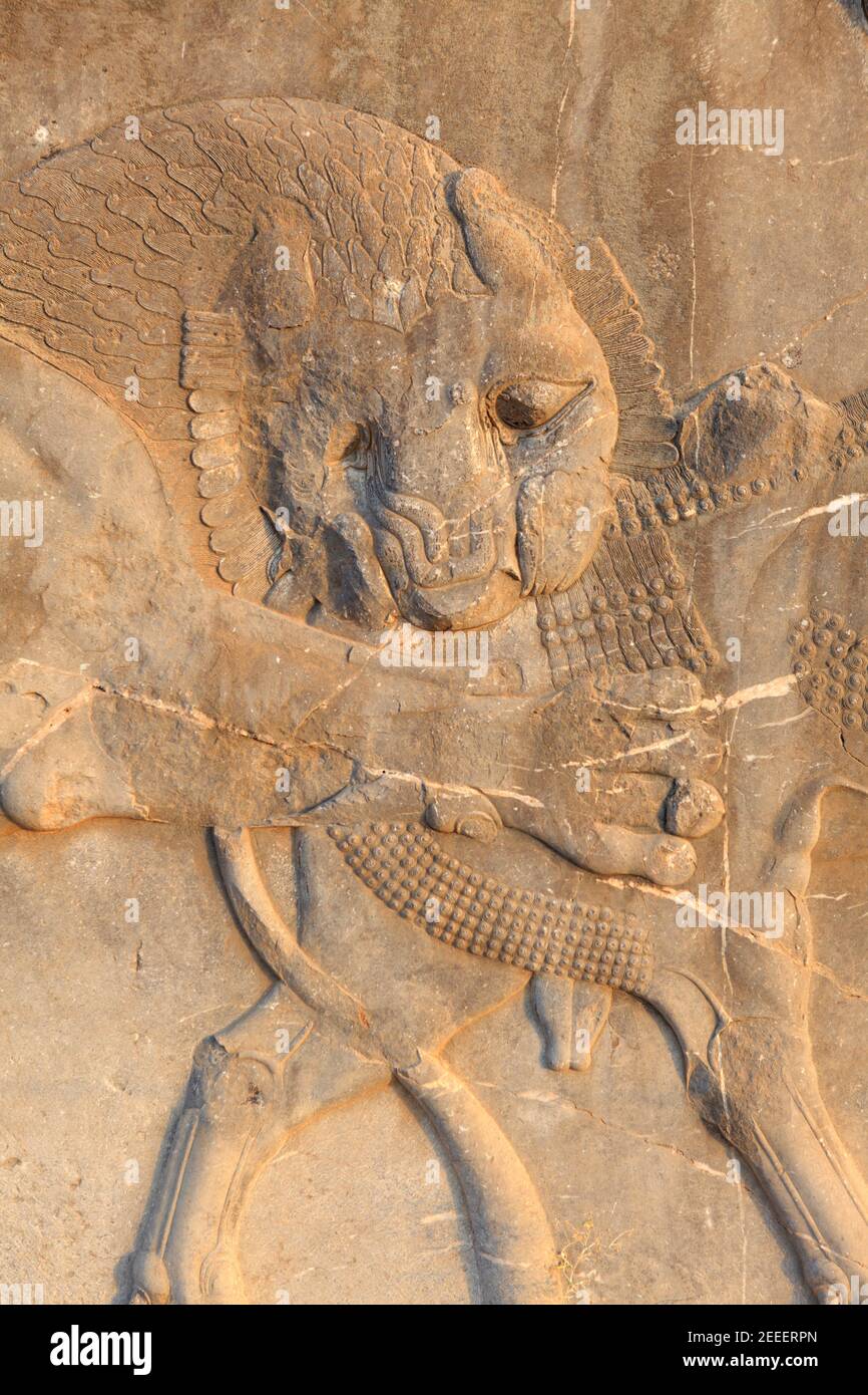 Scene from Persian mythology in the Apadana stairs, Persepolis, Iran ...