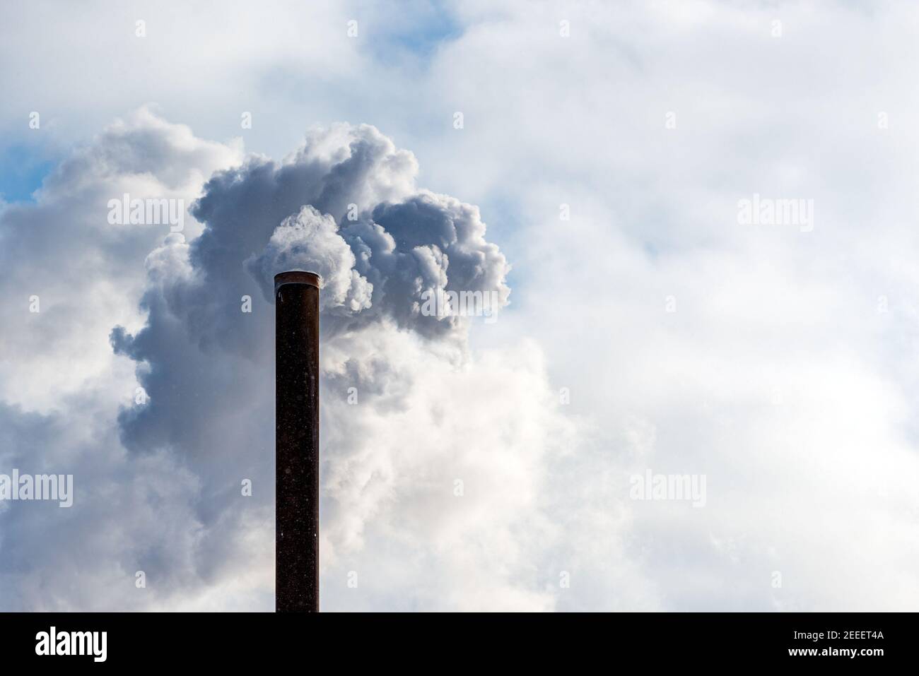 One Industrial smoke pipe from chimney on cloudy sky.White smoke ...