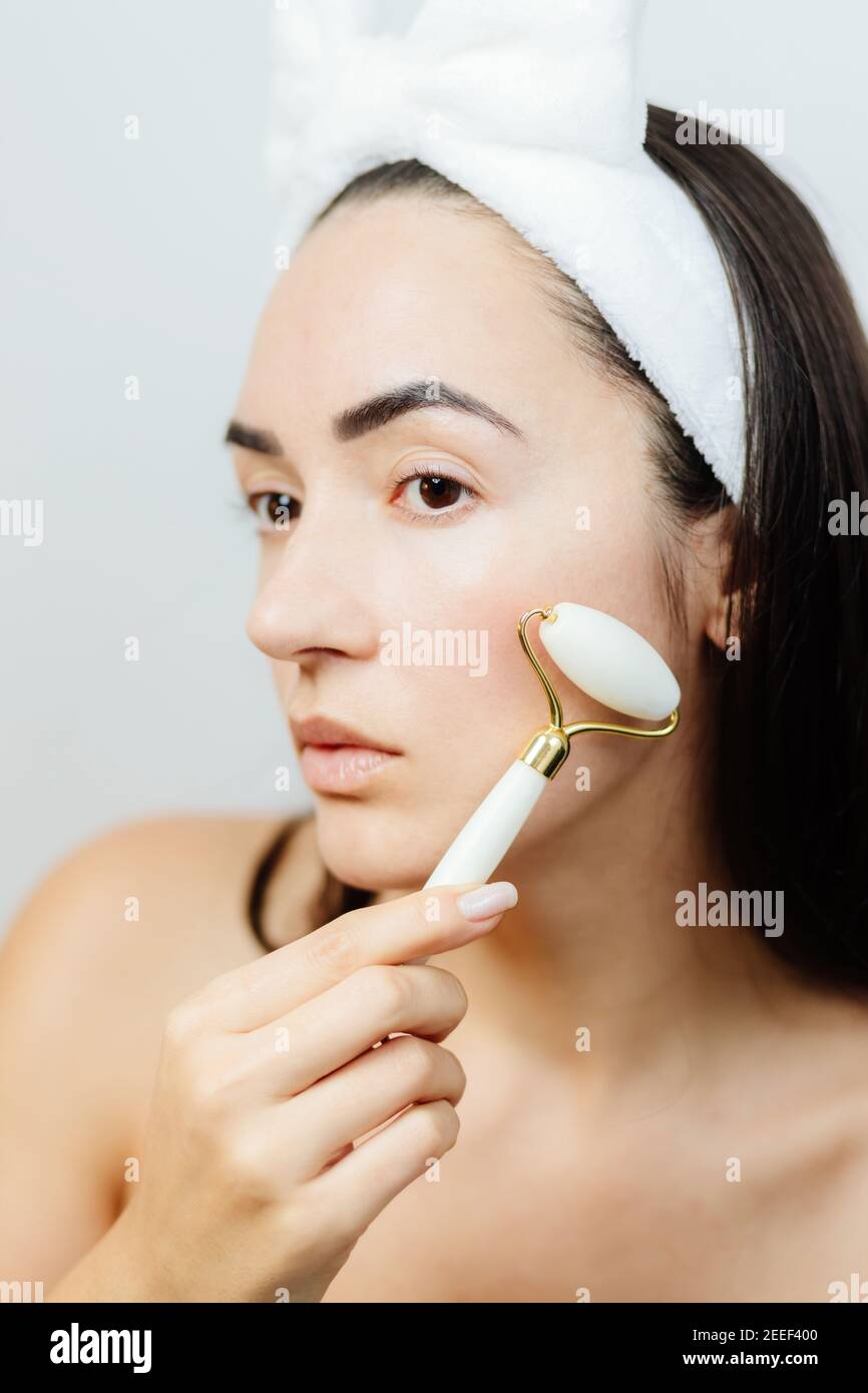 Woman doing anti-aging massage for face skin Stock Photo - Alamy