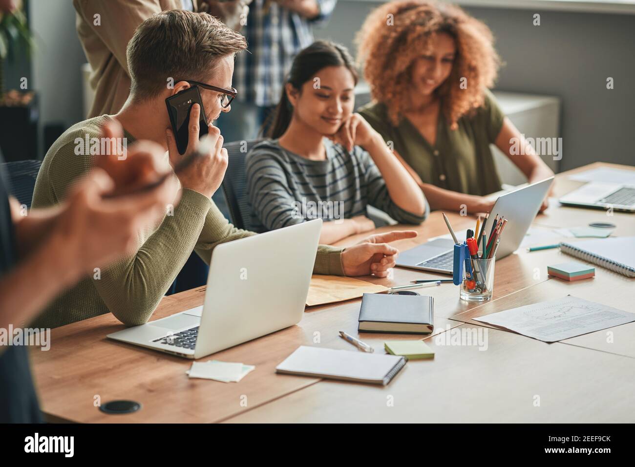 Ambitious man working side by side with young women Stock Photo - Alamy