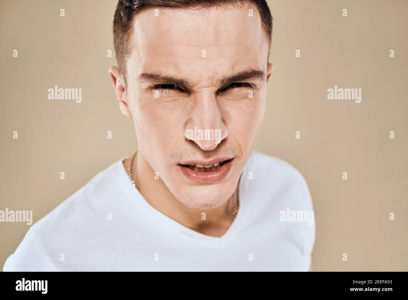 Man with displeased facial expression emotions white t-shirt gestures ...