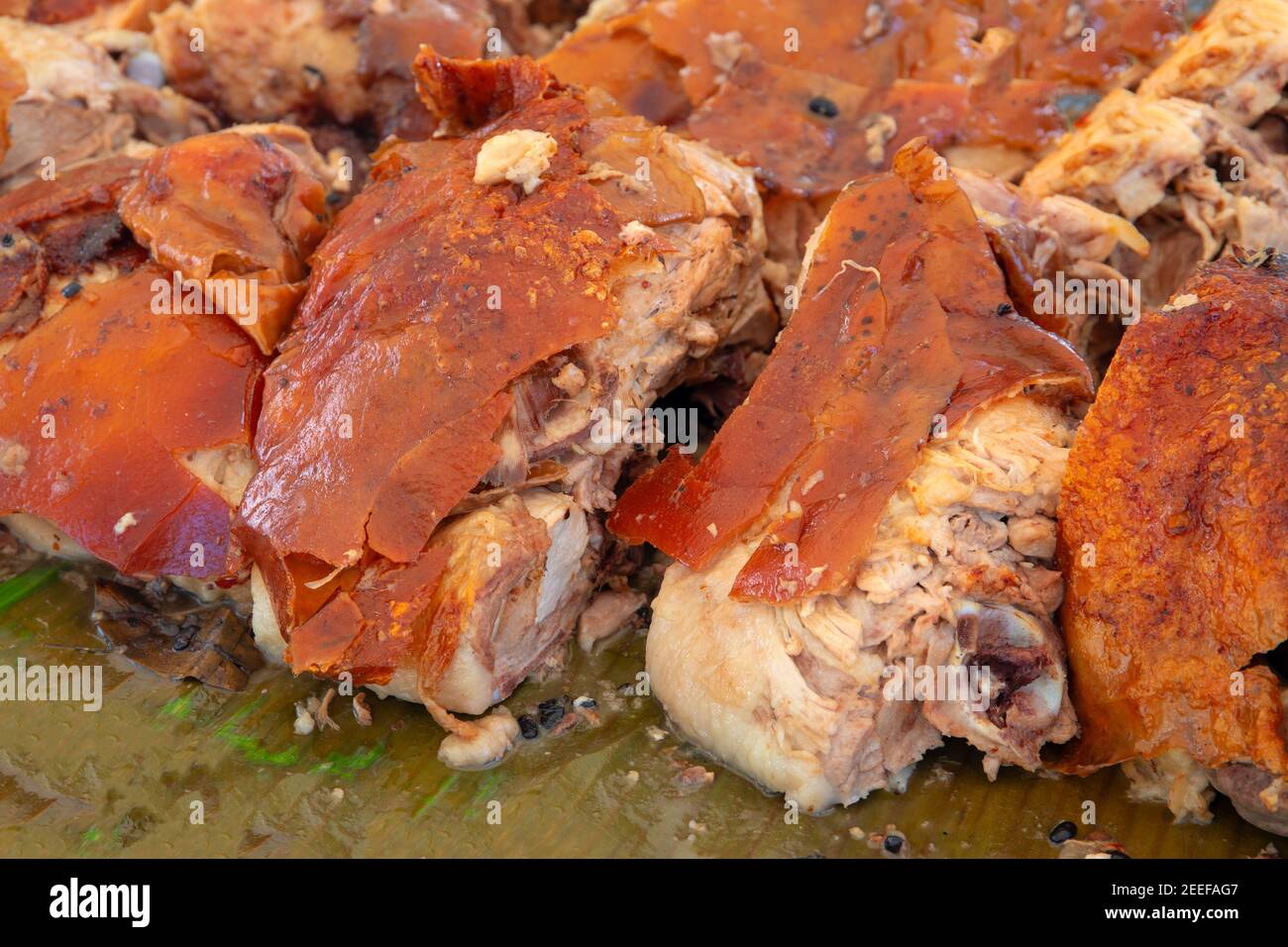 Roasted meat Lechon on banana leaf. Filipino eatery with grilled pork ...