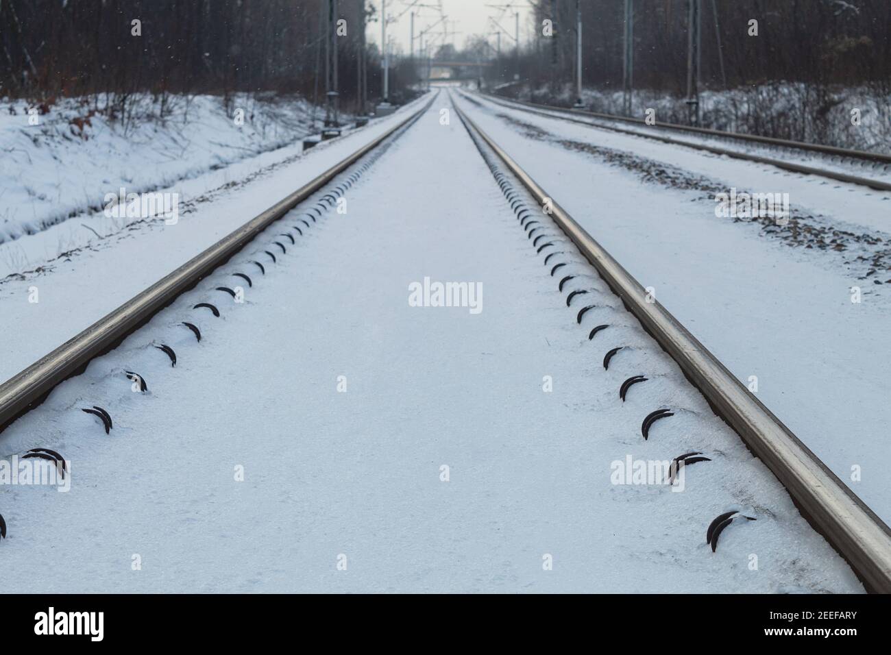 The rails are covered with snow, View along the railway. The rails in ...