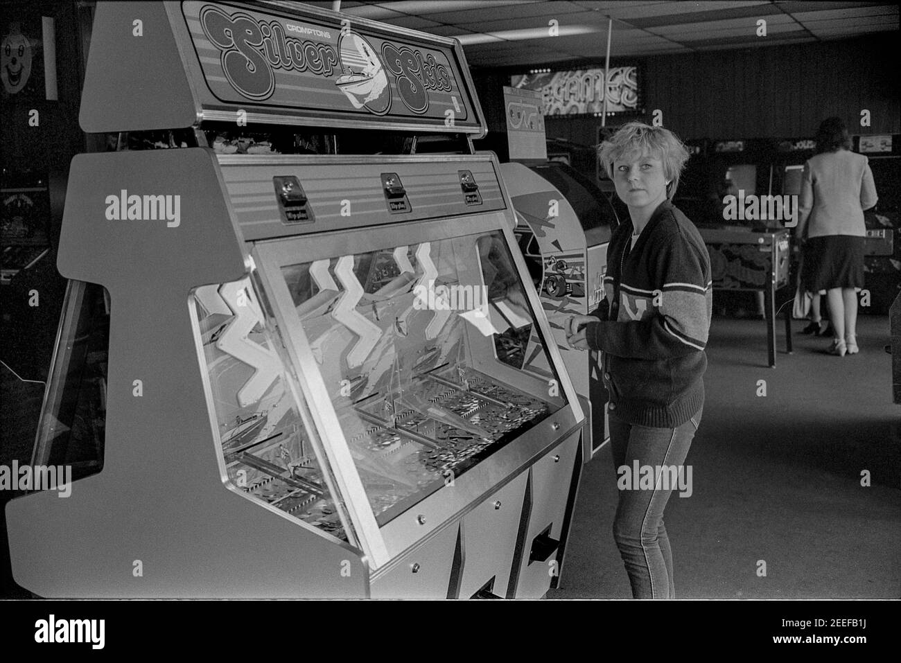 Young Girl at Penny Drop Machine Stock Photo - Alamy