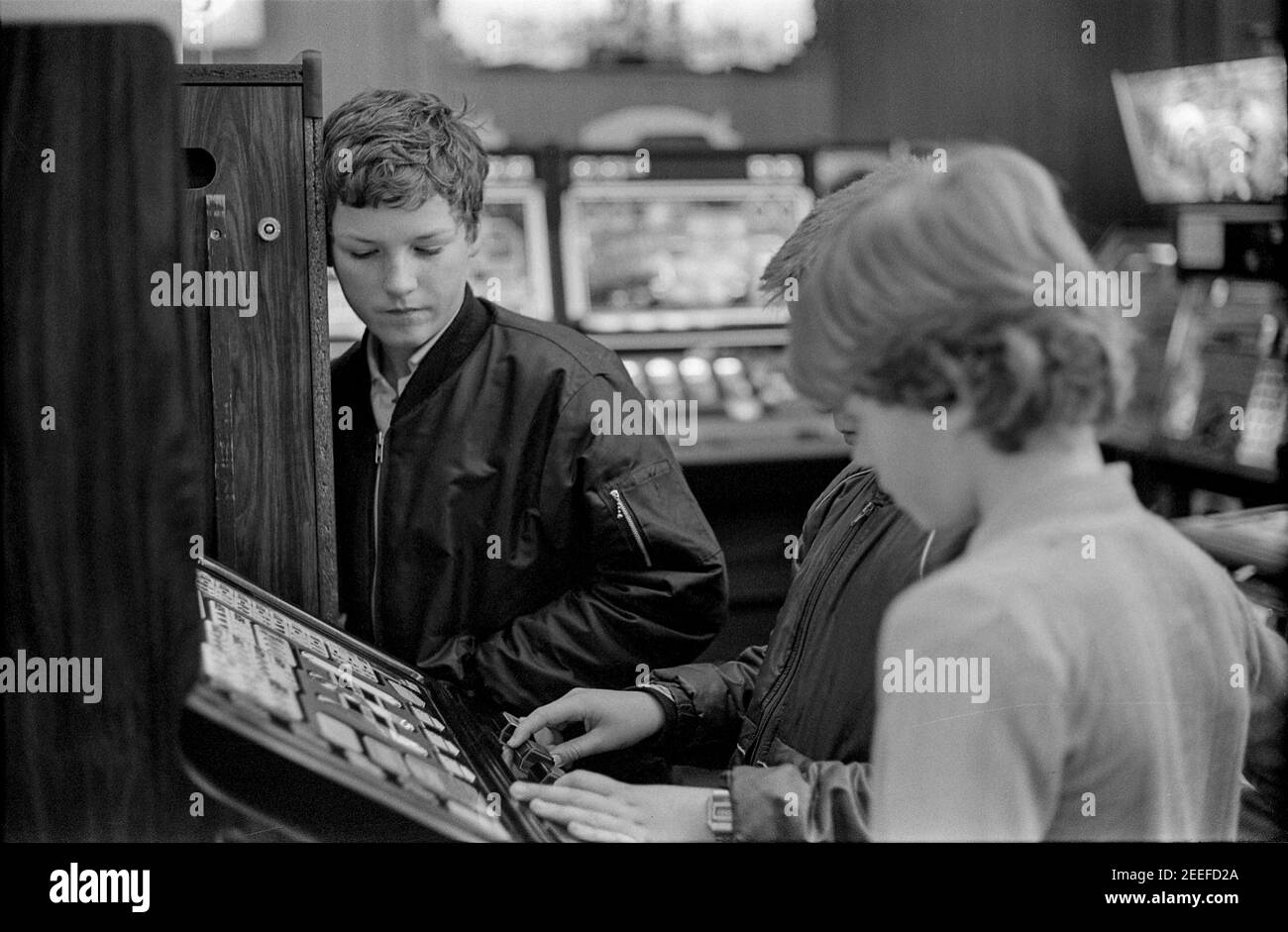 Young People Playing Fruit Machine Stock Photo - Alamy