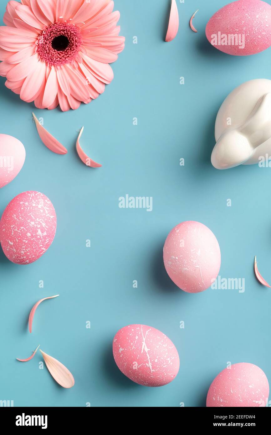 Happy Easter flat lay style composition. Top view pink Easter eggs, spring flower, bunny rabbit ...