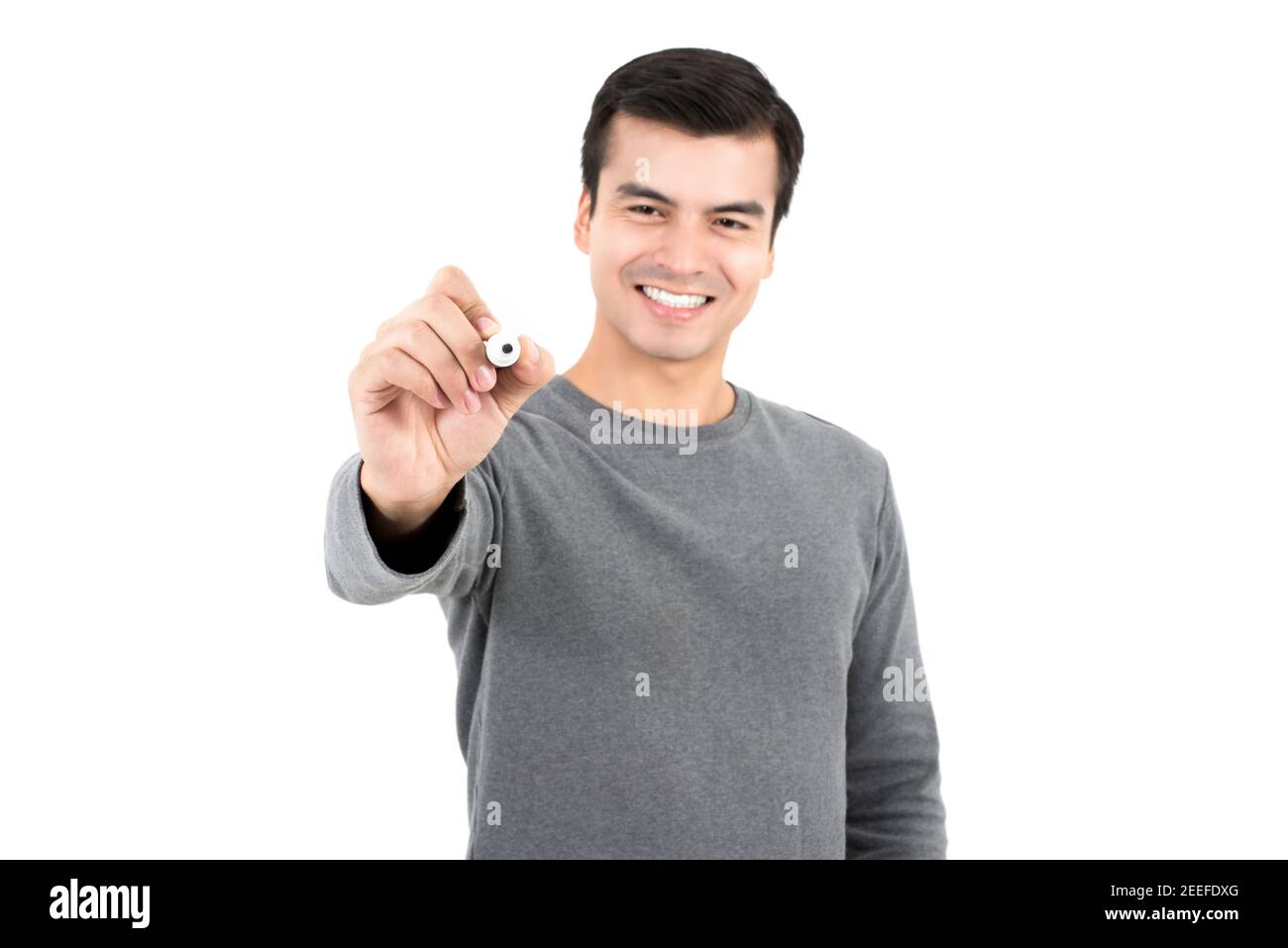 Young smiling casual Hispanic man writing on empty virtual screen in ...