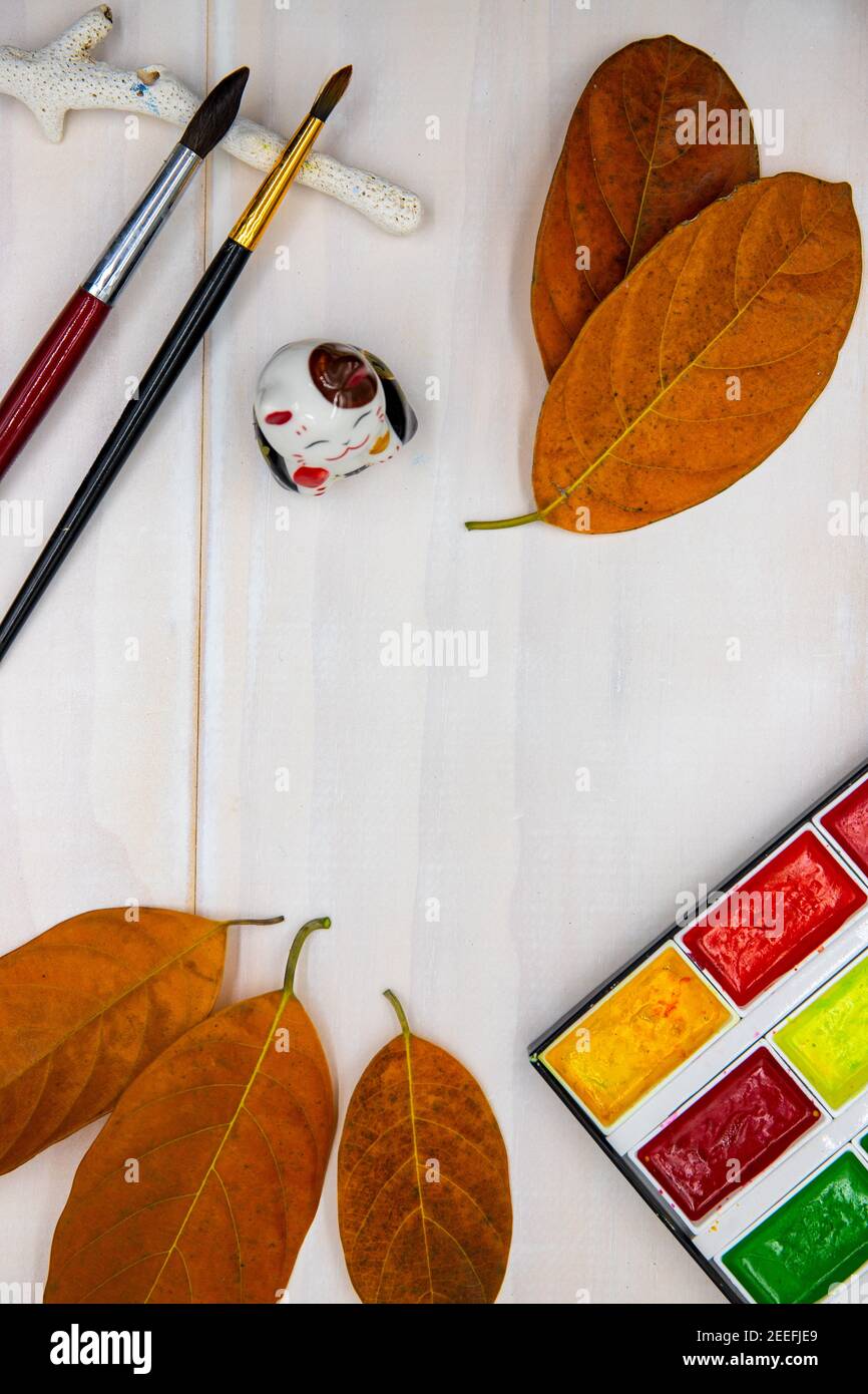 Artist table top view with orange leaf and watercolors. Autumn leaf ...