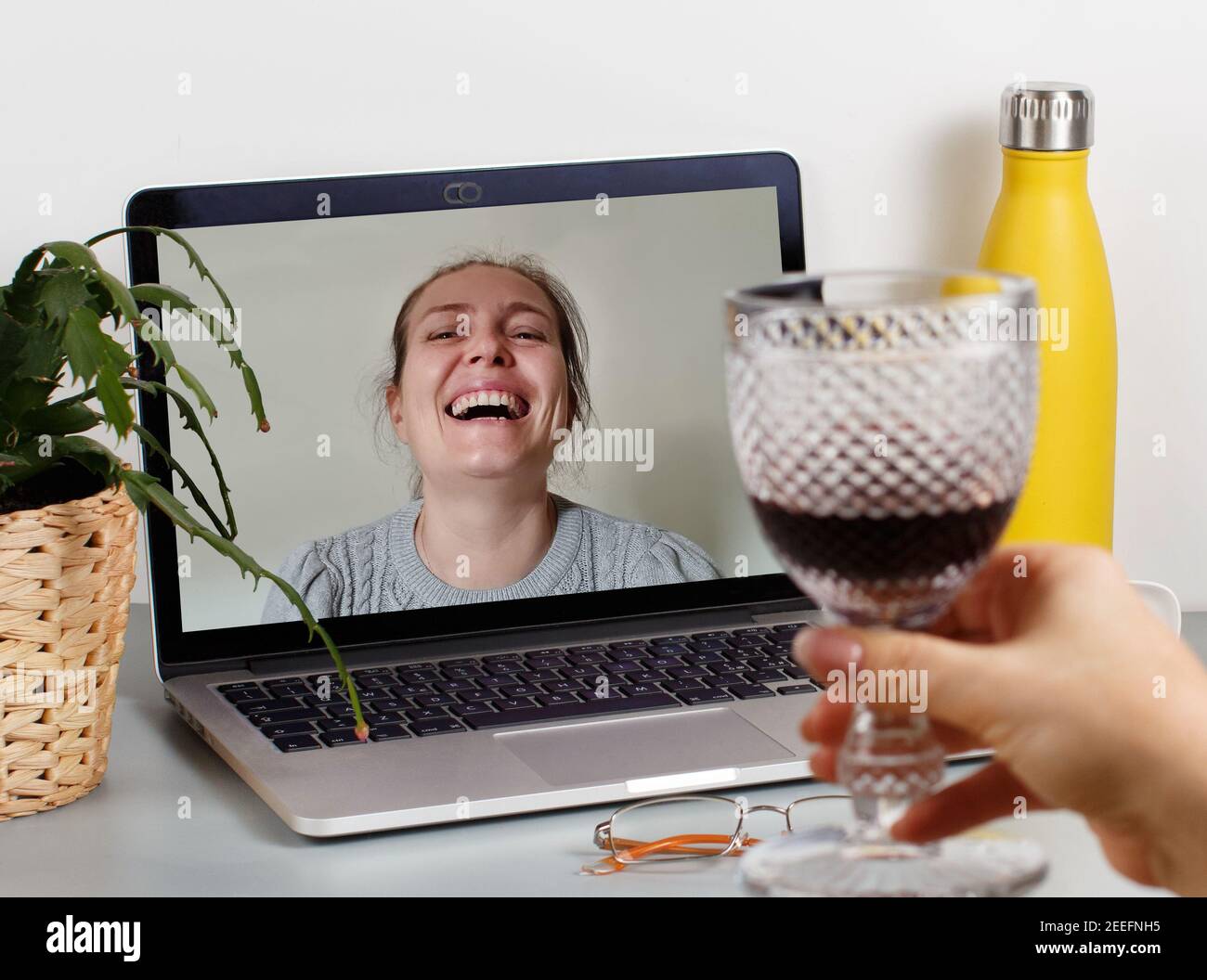 Two friends drinking wine while having a video call close up Stock ...