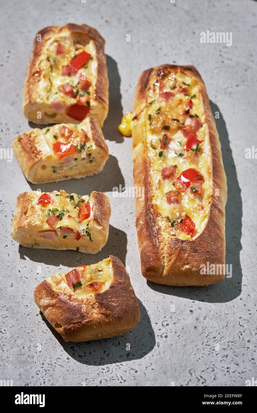 Bread boats stuffed with ham, egg, green onion and cheese for breakfast ...