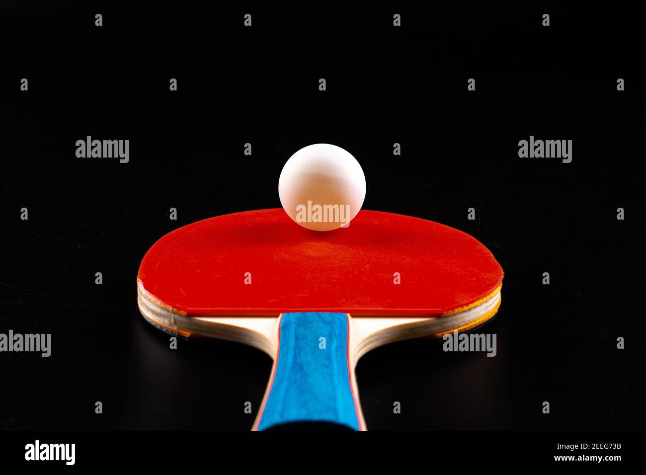 Red ping pong racket on dark background Stock Photo - Alamy