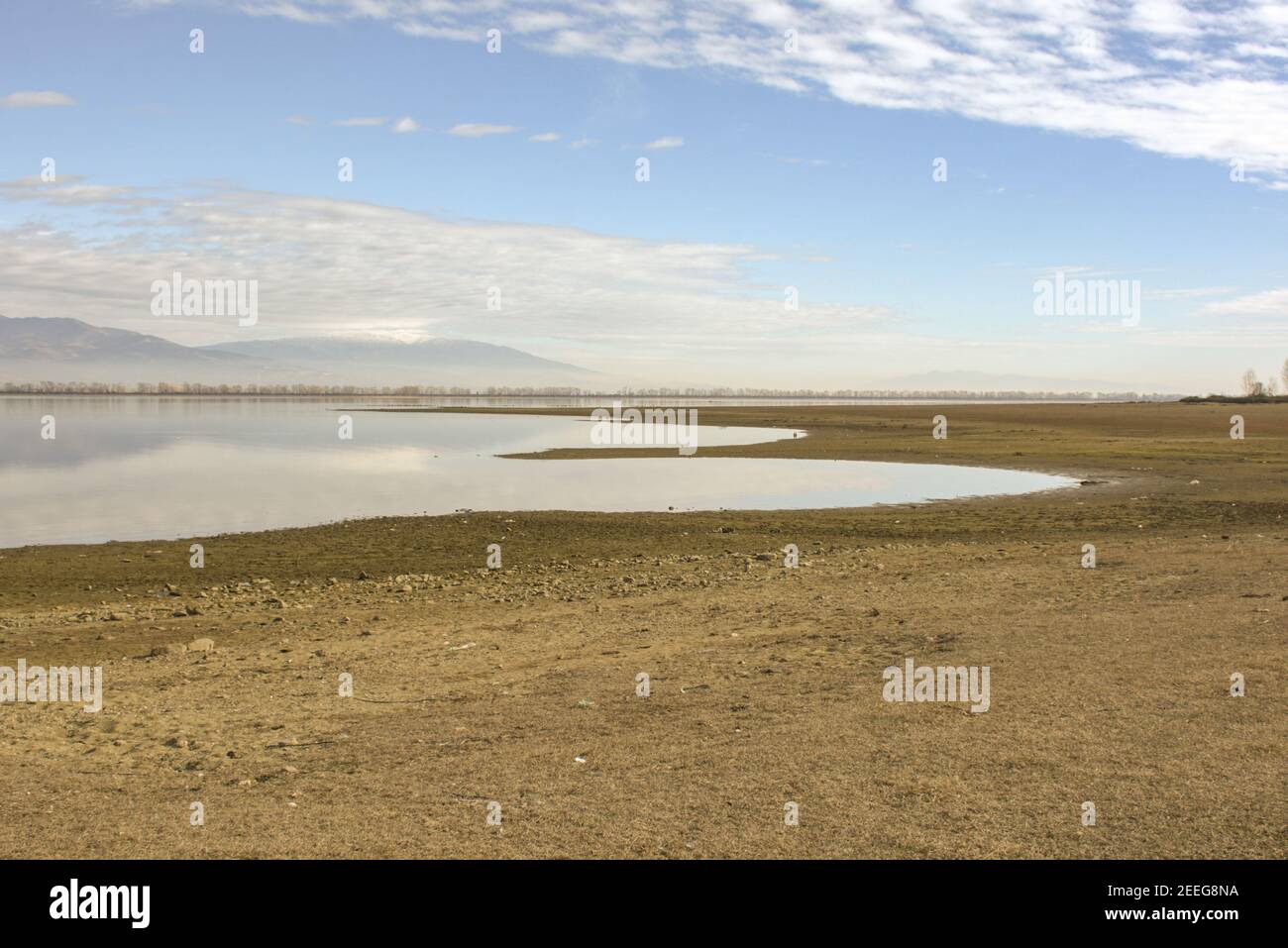 Empty bay of a lake reflecting the cloudy sky Stock Photo - Alamy