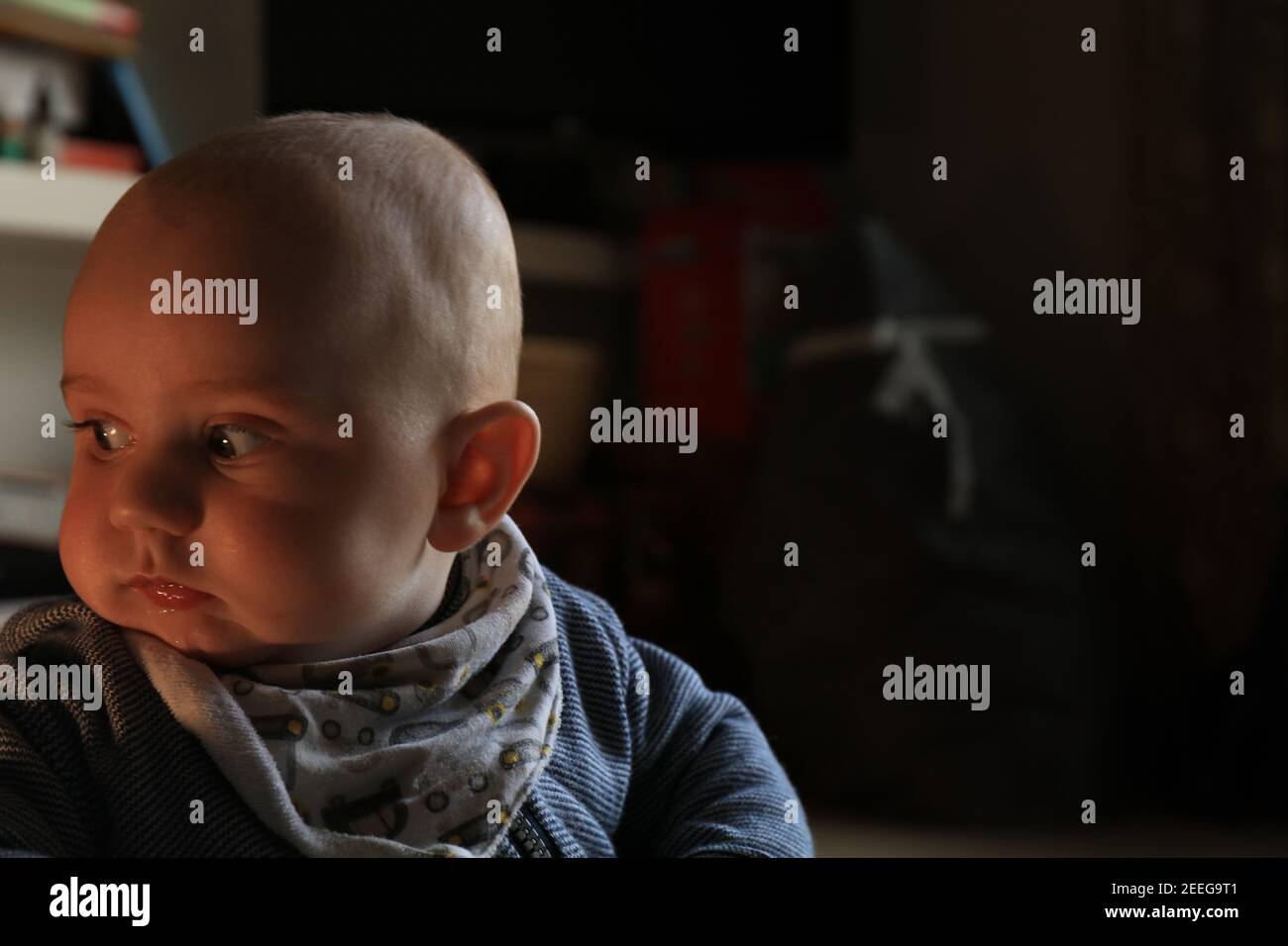 Portrait of baby boy in a domestic room inside of the house with ...