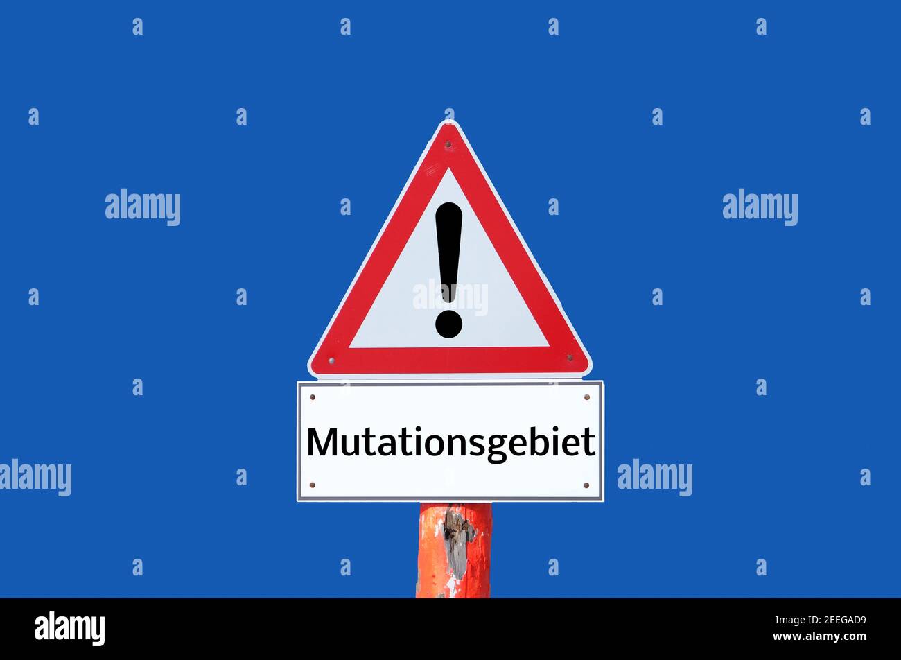 Warning sign mutation area on blue background in german Stock Photo - Alamy