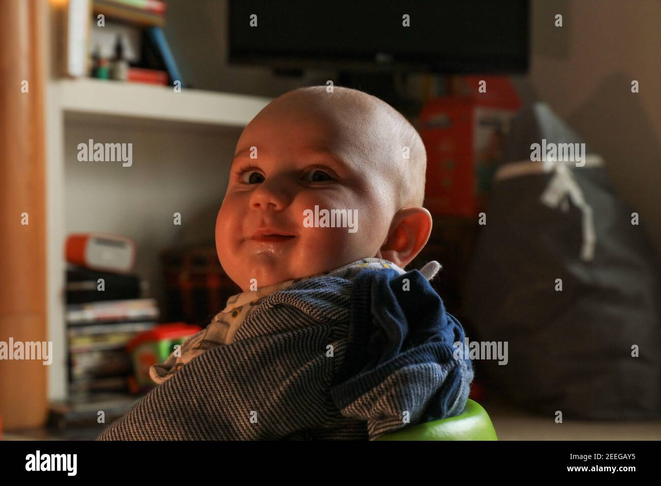 Portrait of baby boy in a domestic room inside of the house with ...