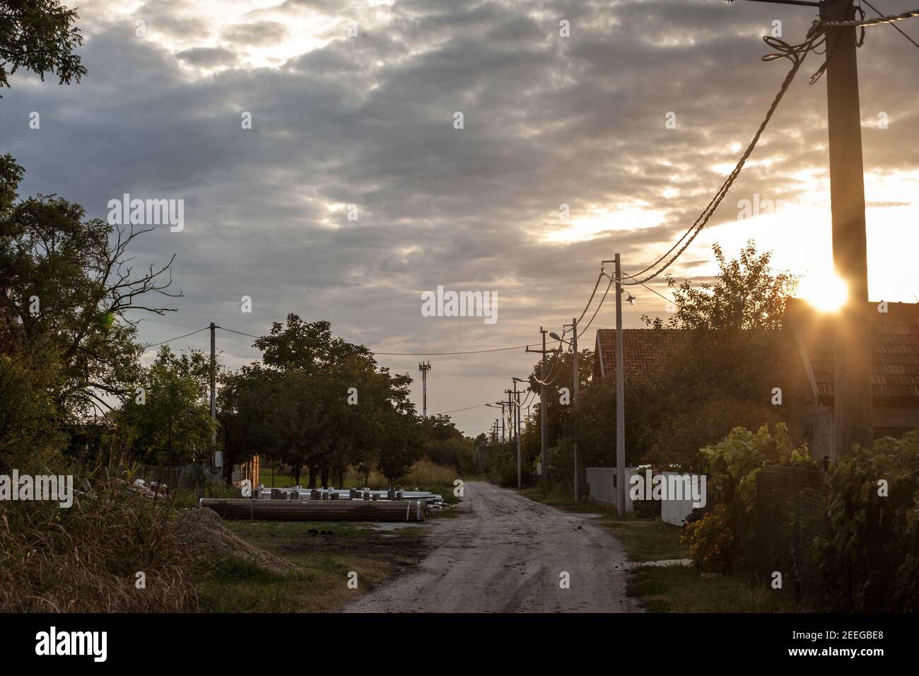 Unpaved non asphalted road and street, a dirtpath, in a village at ...