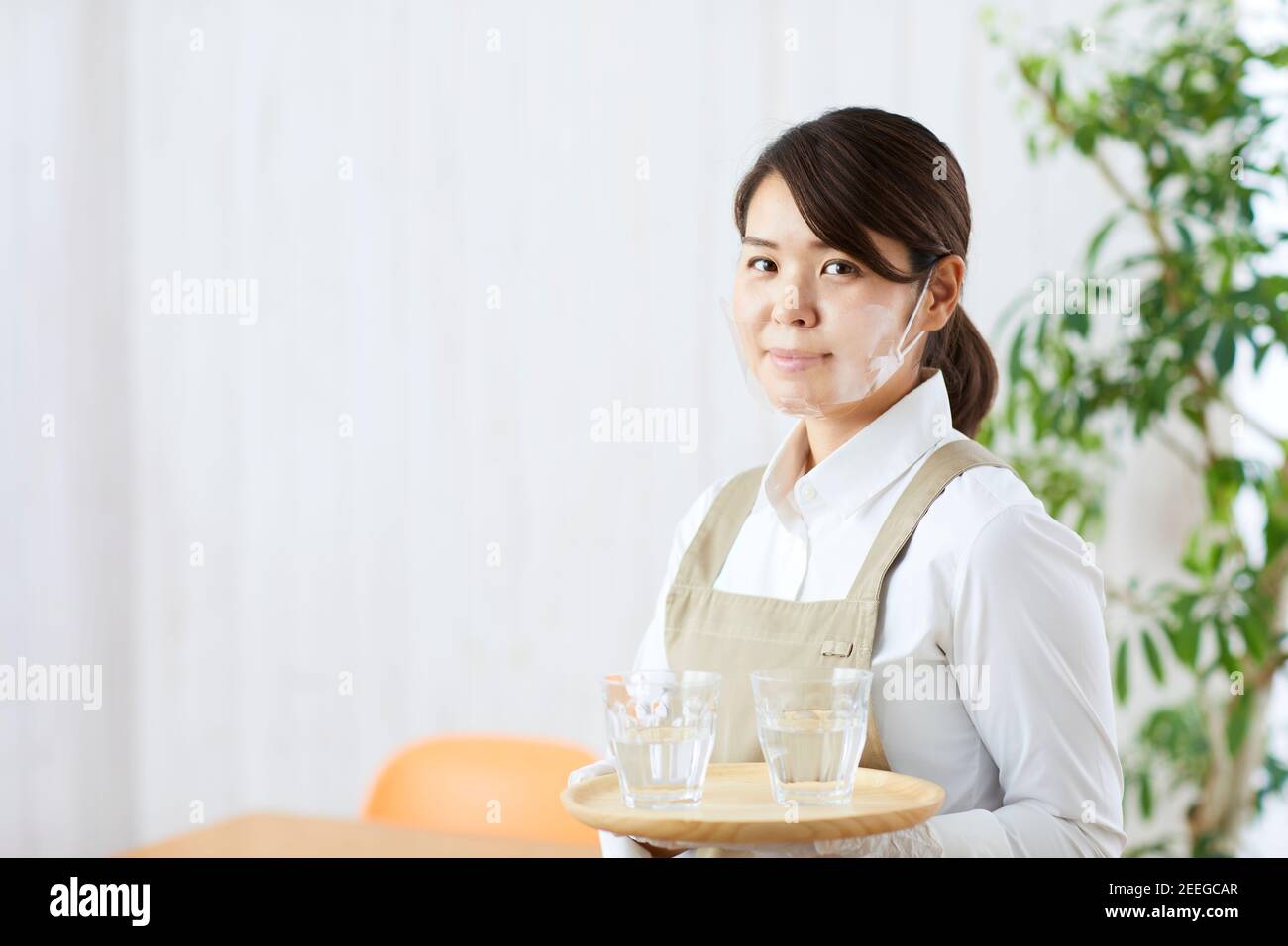 Japanese woman wearing face shield Stock Photo - Alamy
