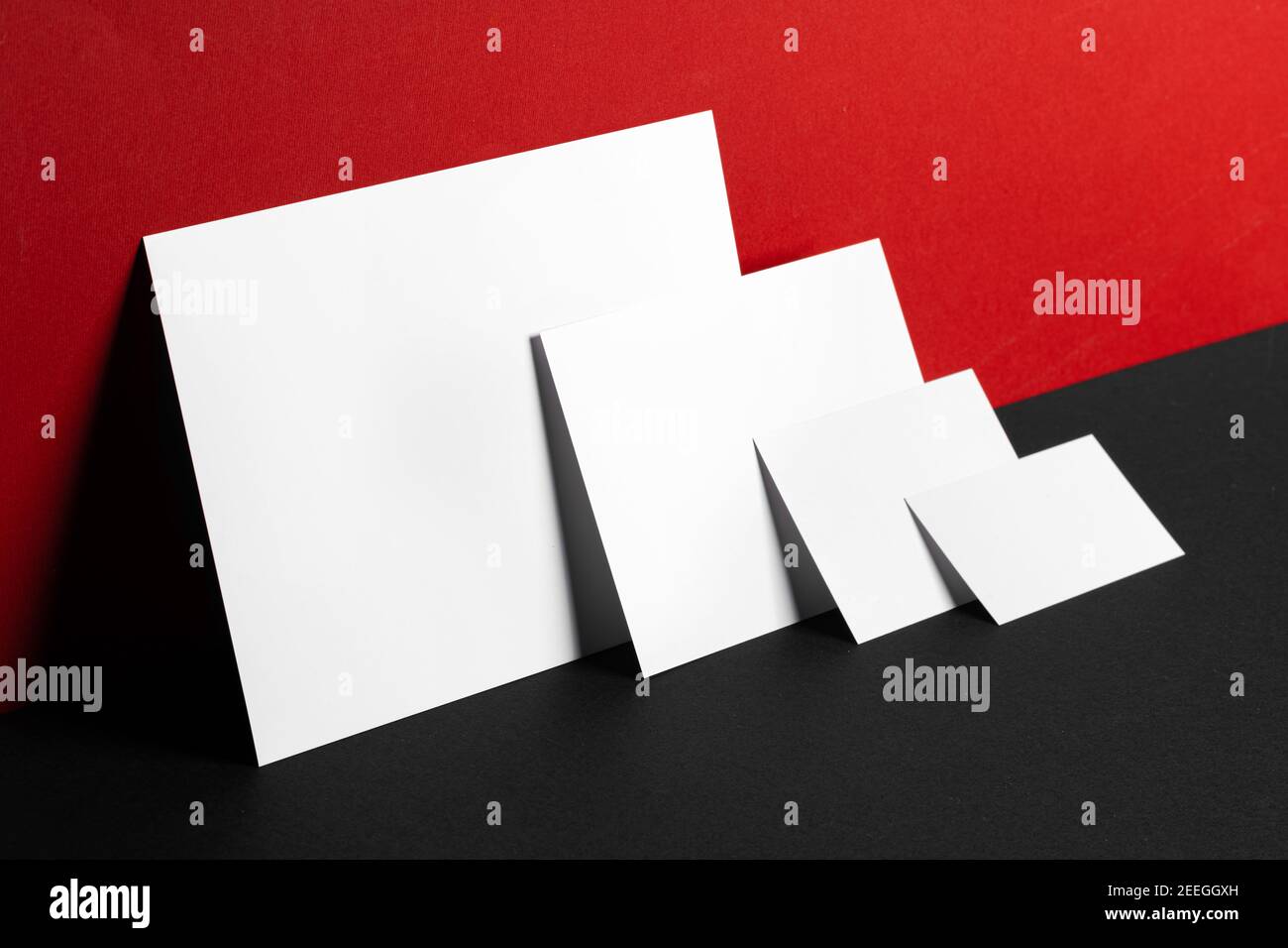 Blank white business cards on red and black paper background Stock ...