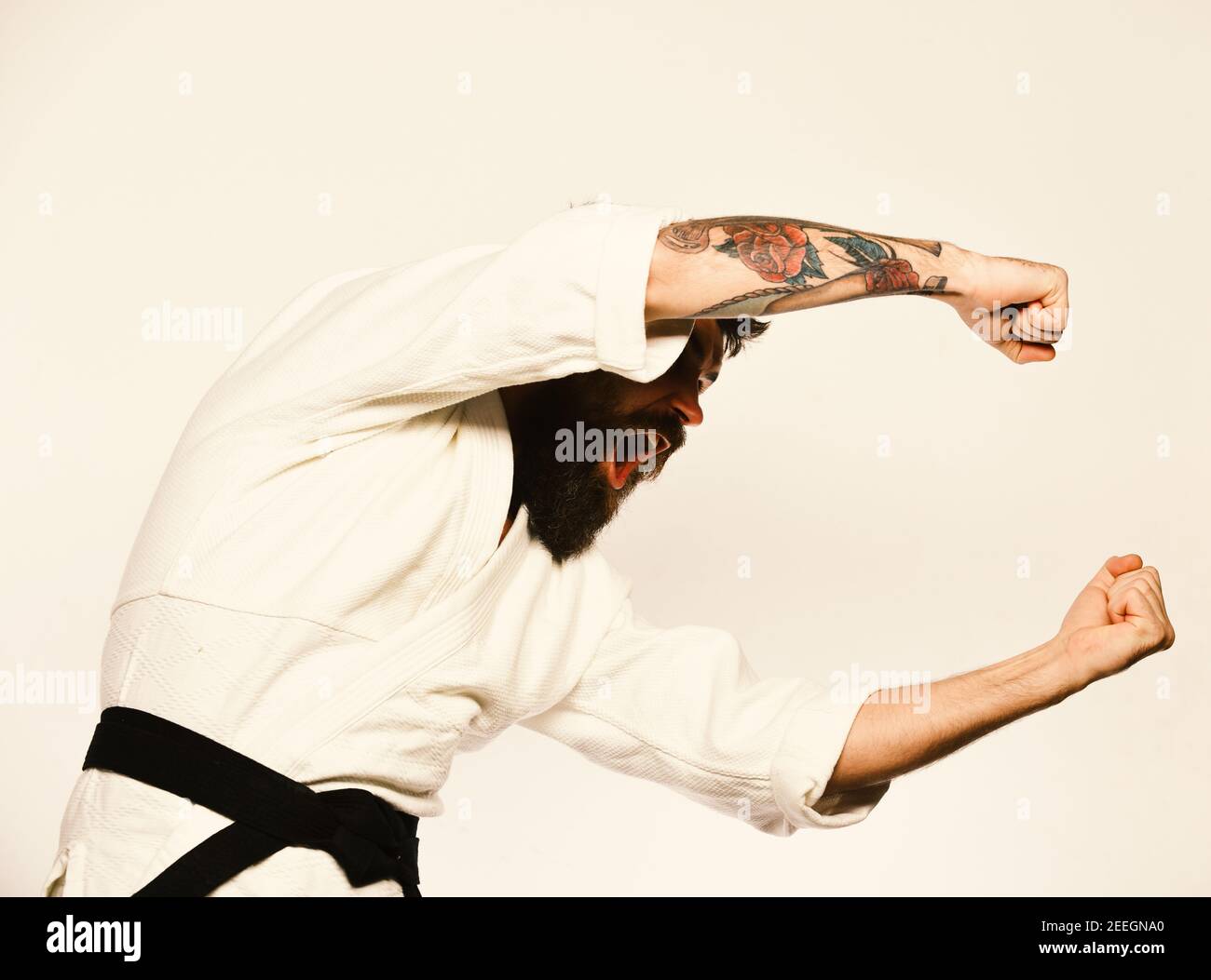 Karate man with busy face in uniform. Jiu Jitsu master with black belt ...