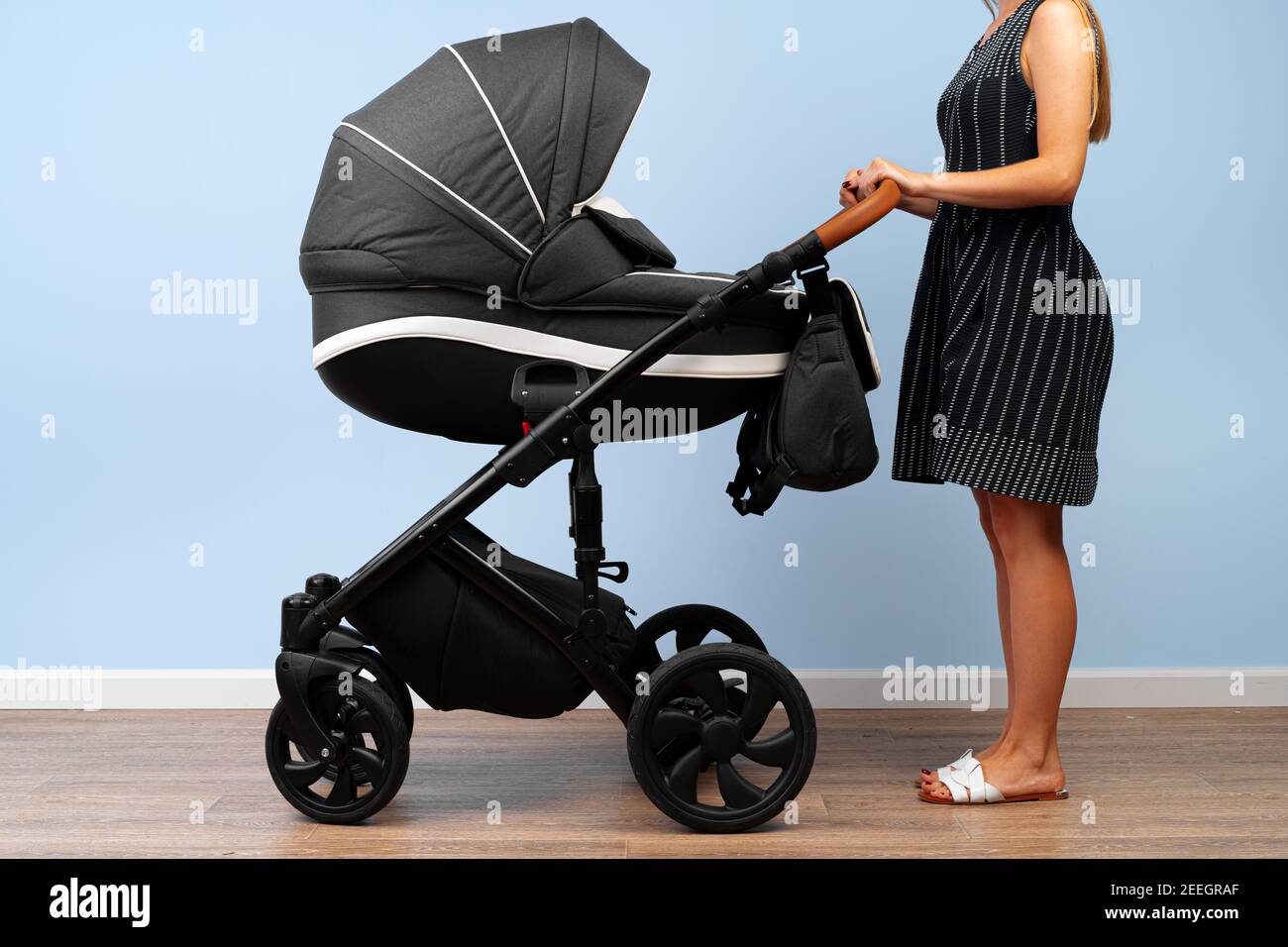Woman with baby cart standing hi-res stock photography and images - Alamy