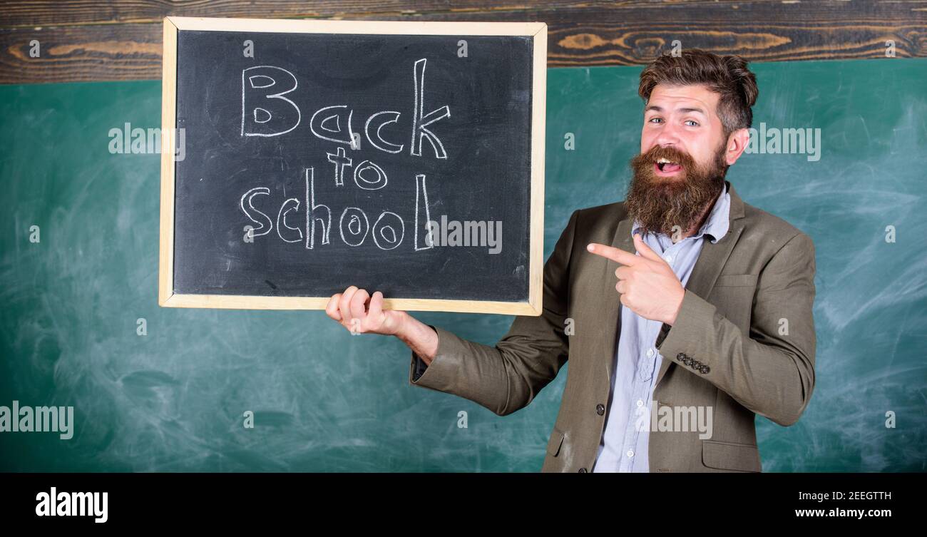 Man bearded holds blackboard inscription back to school. Back to school ...