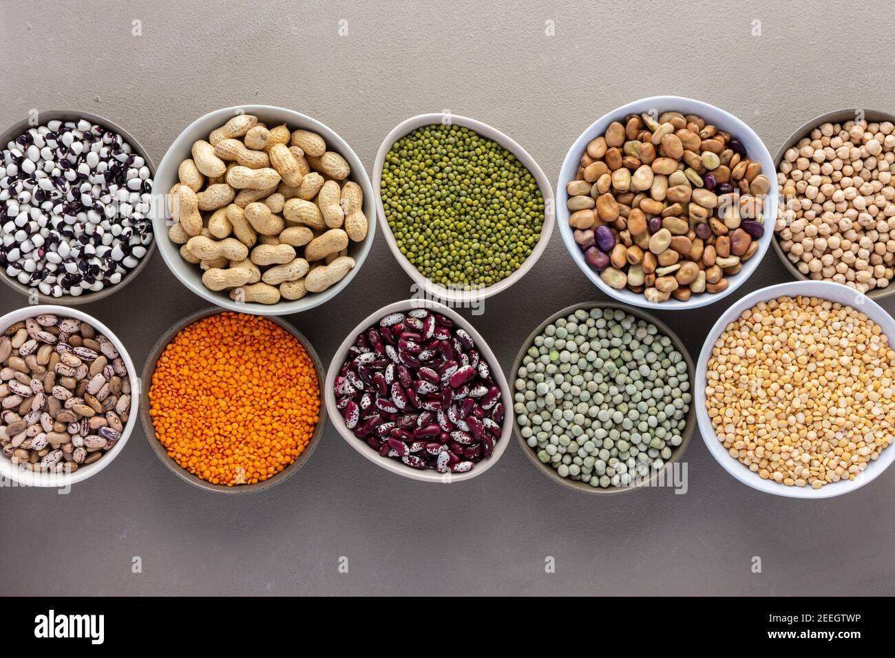 Different types of legumes in bowls, green and yellow peas, chickpeas ...