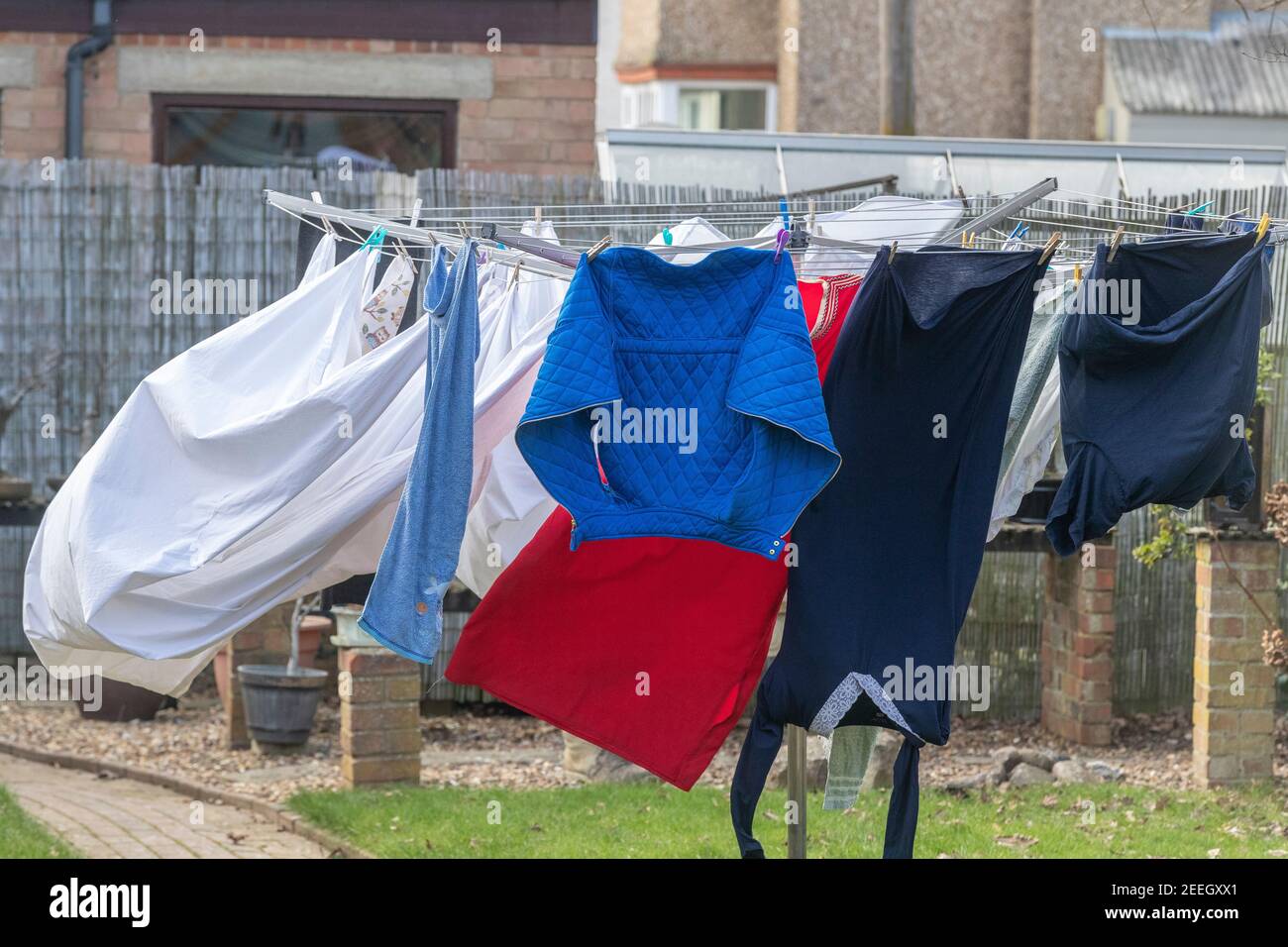 Washing hang on a rotary cloths line blowing in the wind in a ...