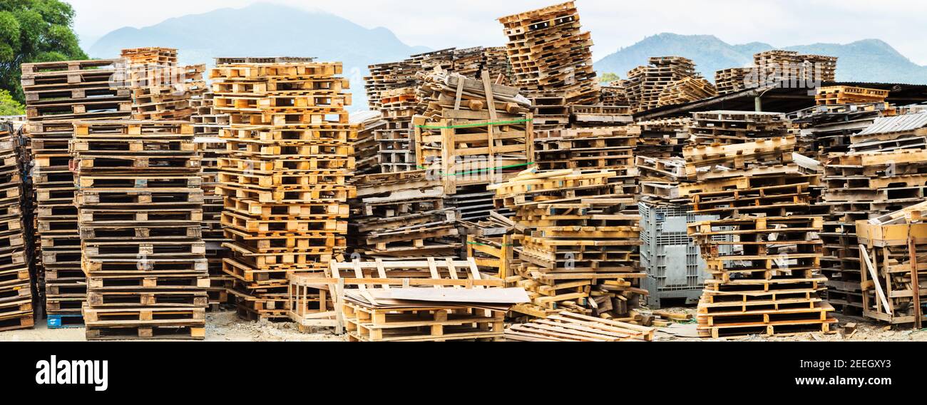 Lot of old pallets in a factory with mountains in the background Stock ...
